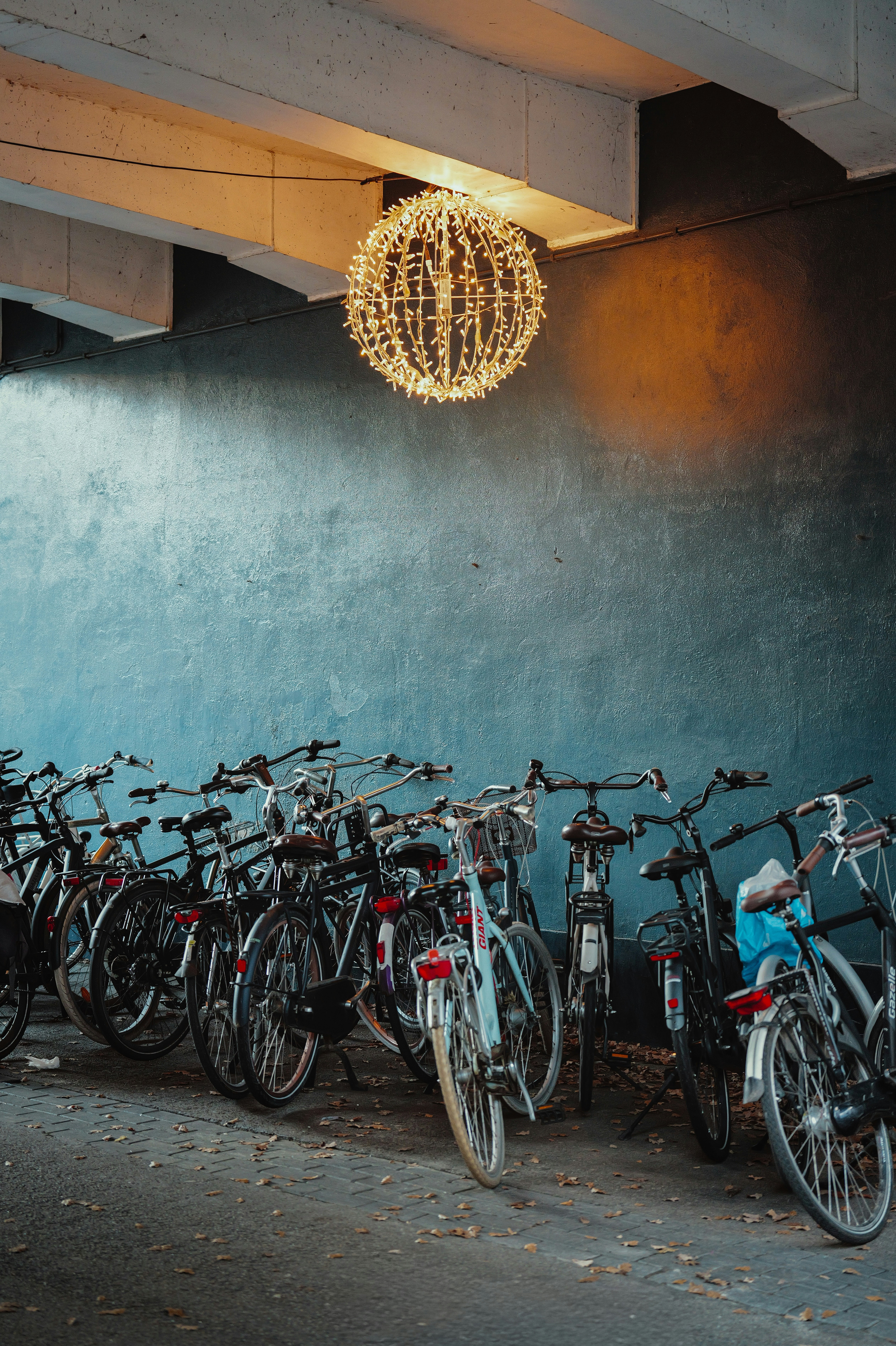 Bicycles parked under a glowing orb light.
