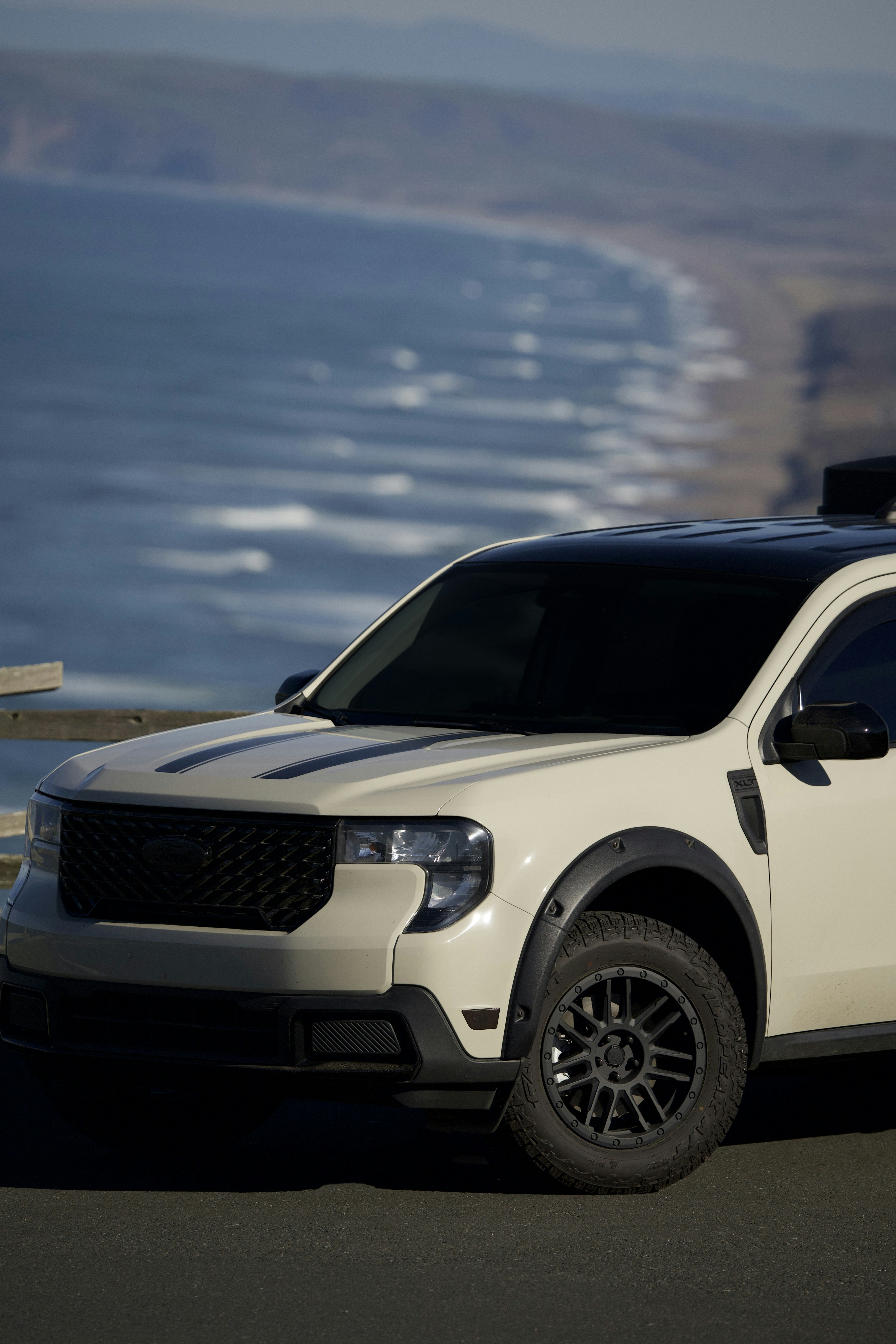 Coastal Edge: White SUV Framed by Sea Cliffs