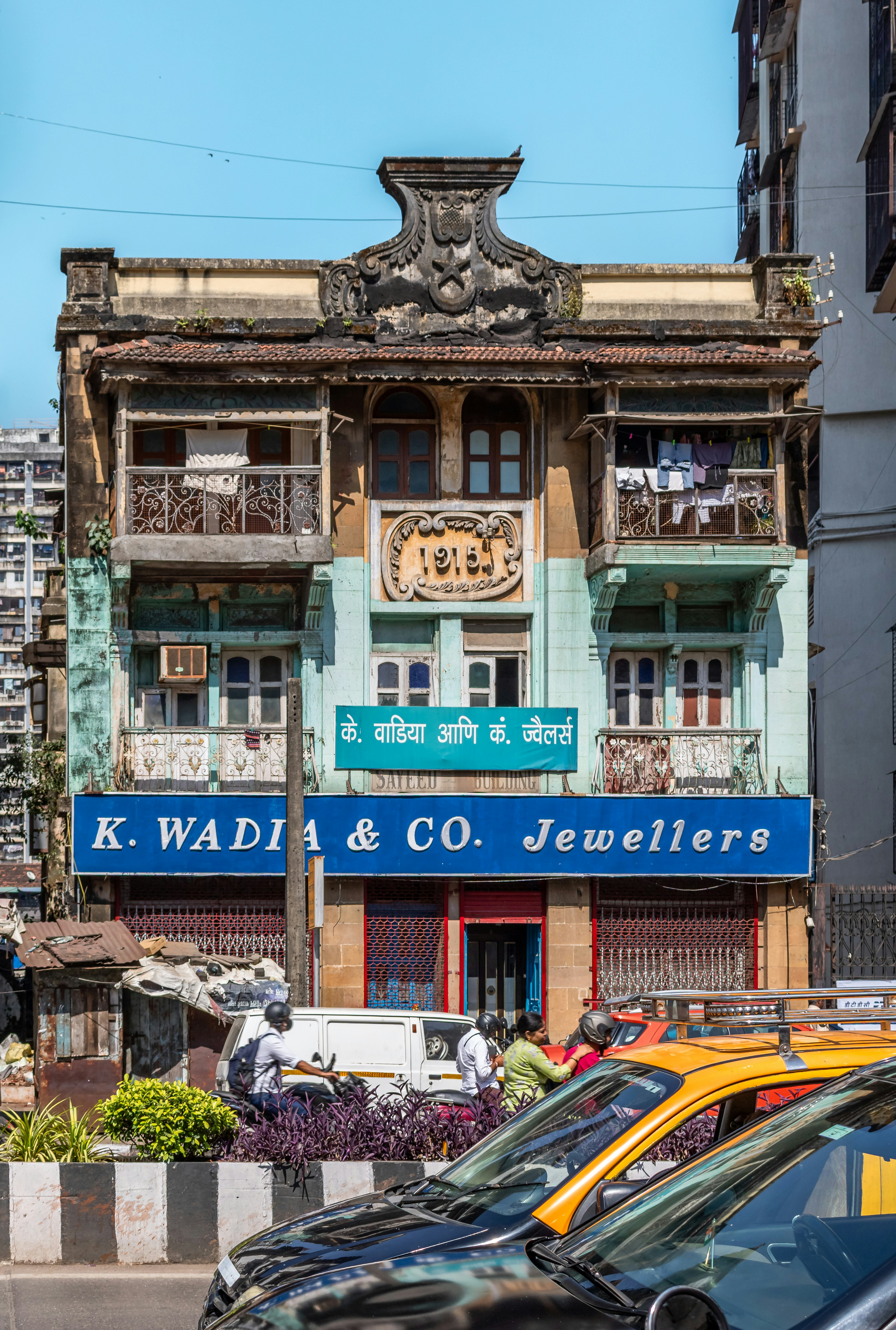 Blue Sign, Turquoise Balconies: A Timeworn Mumbai Jewelers Facade