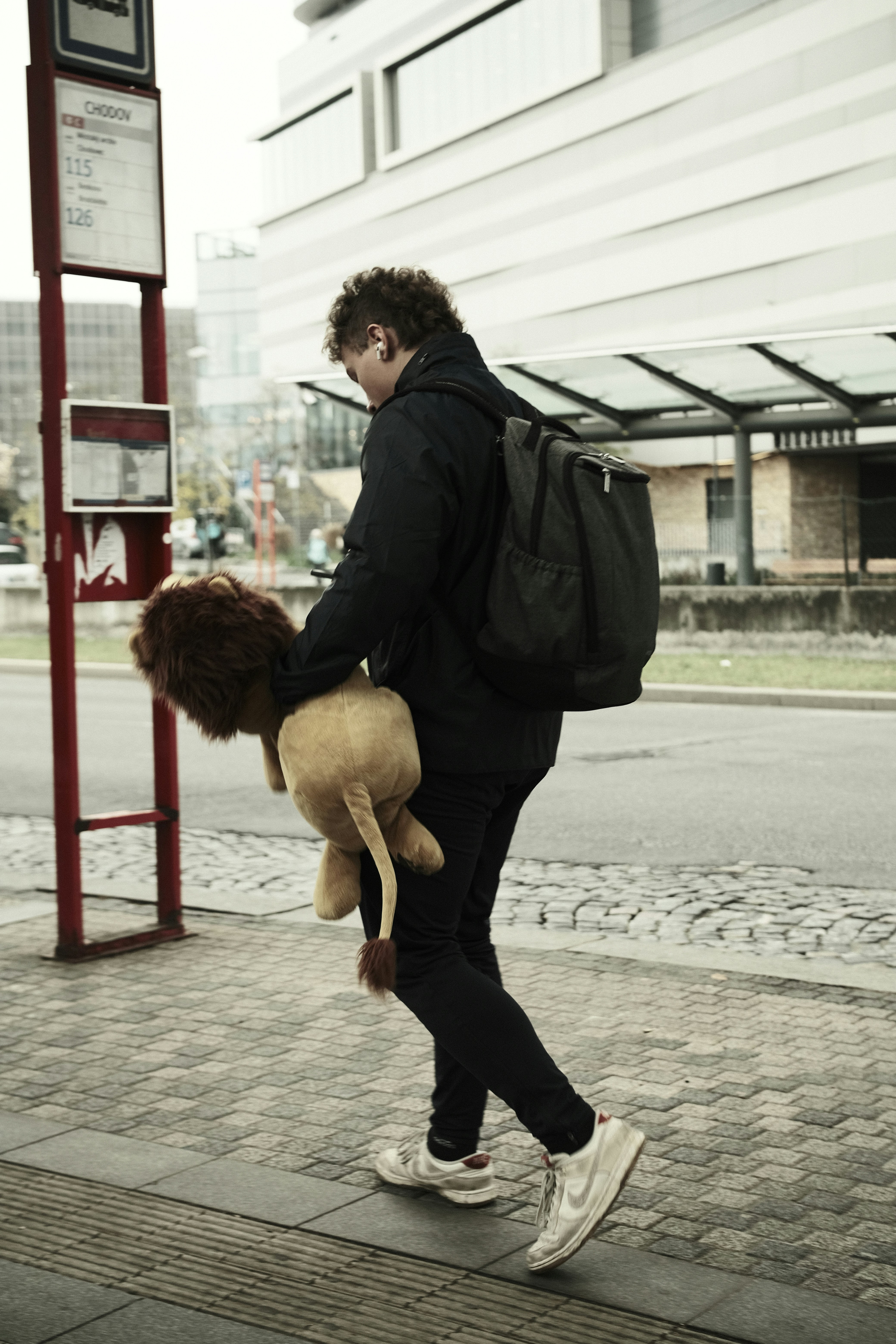 Commute with a Plush Lion: A Quiet Urban Moment