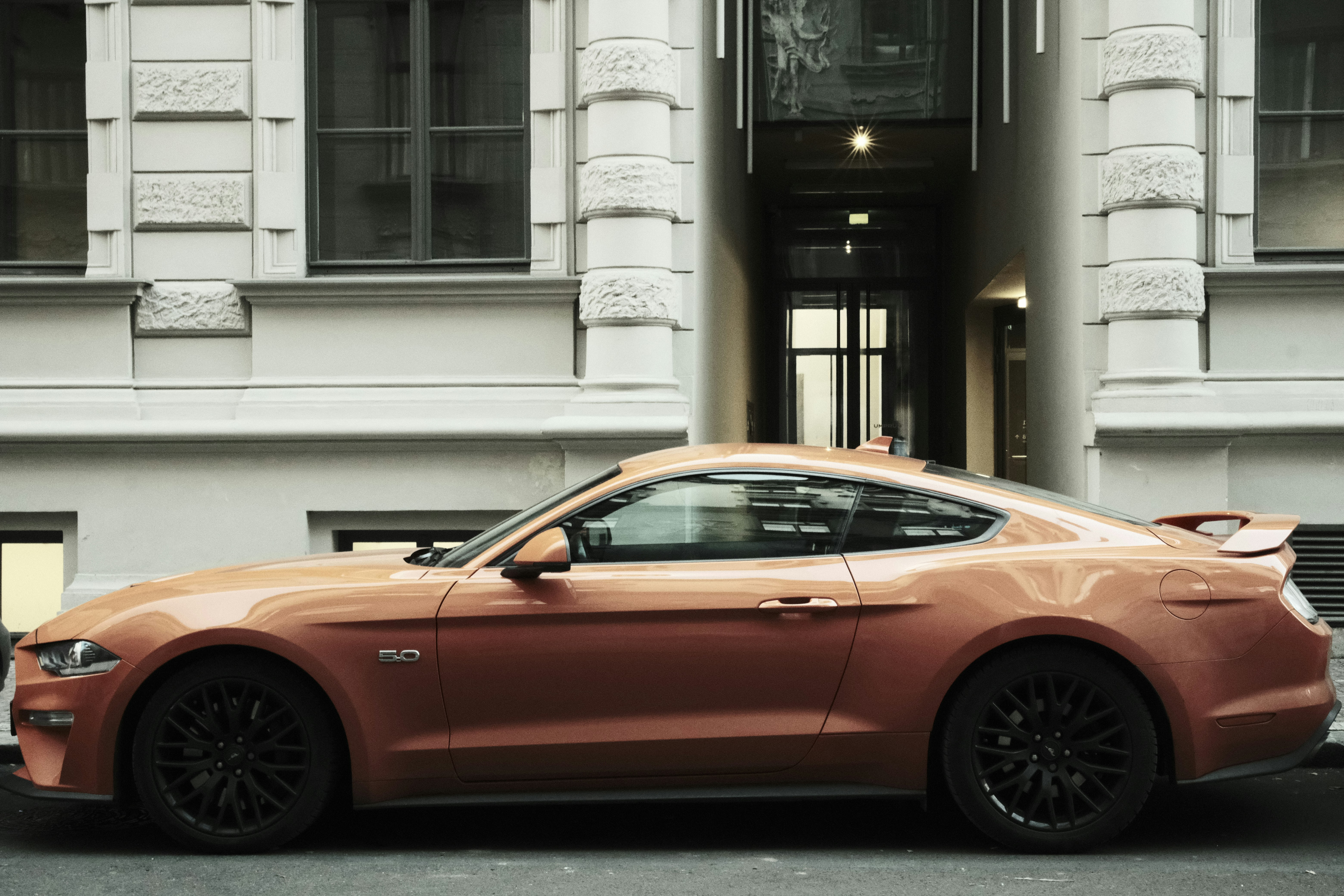 Orange sports car parked in urban area
