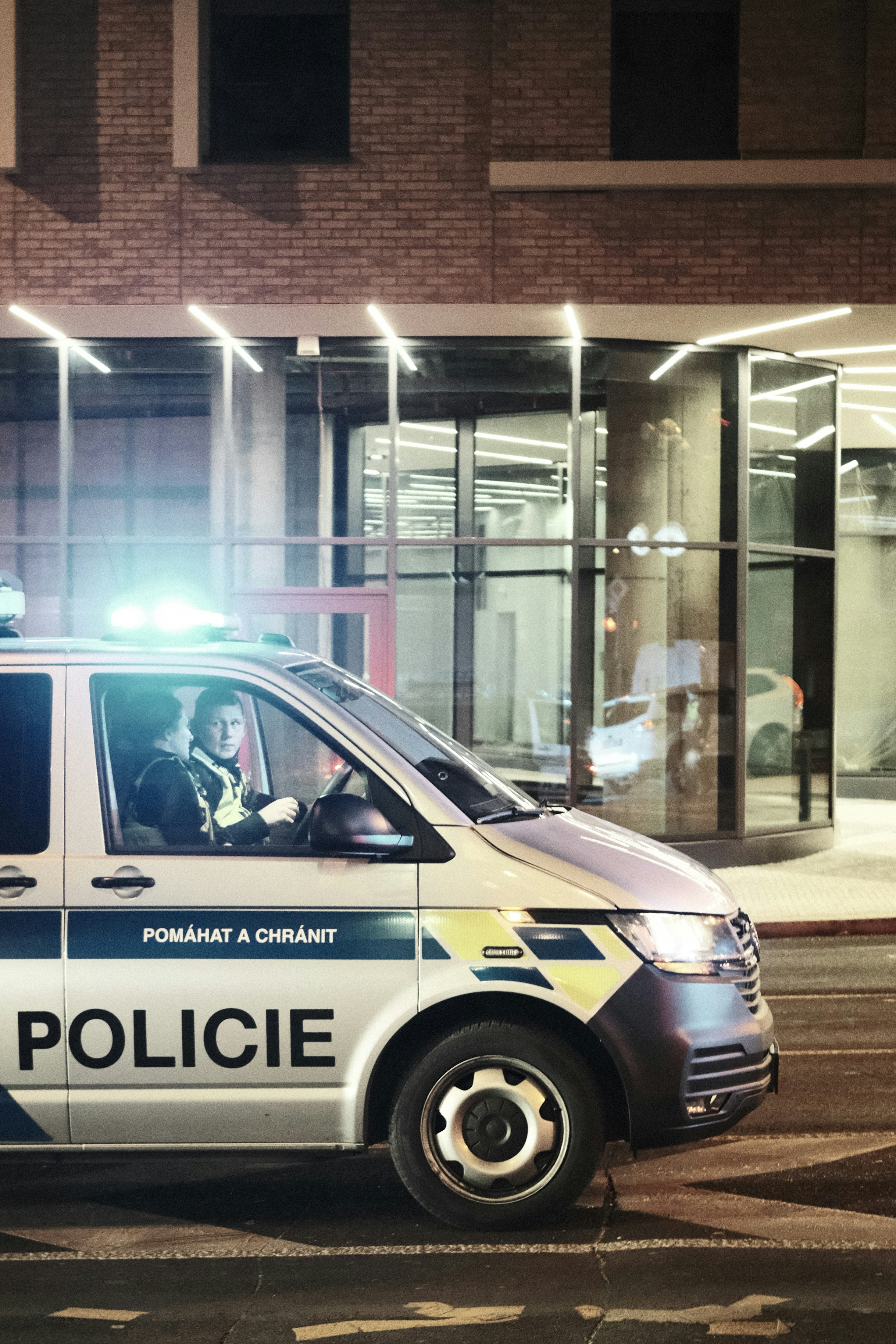 Police vehicle parked on urban street at night