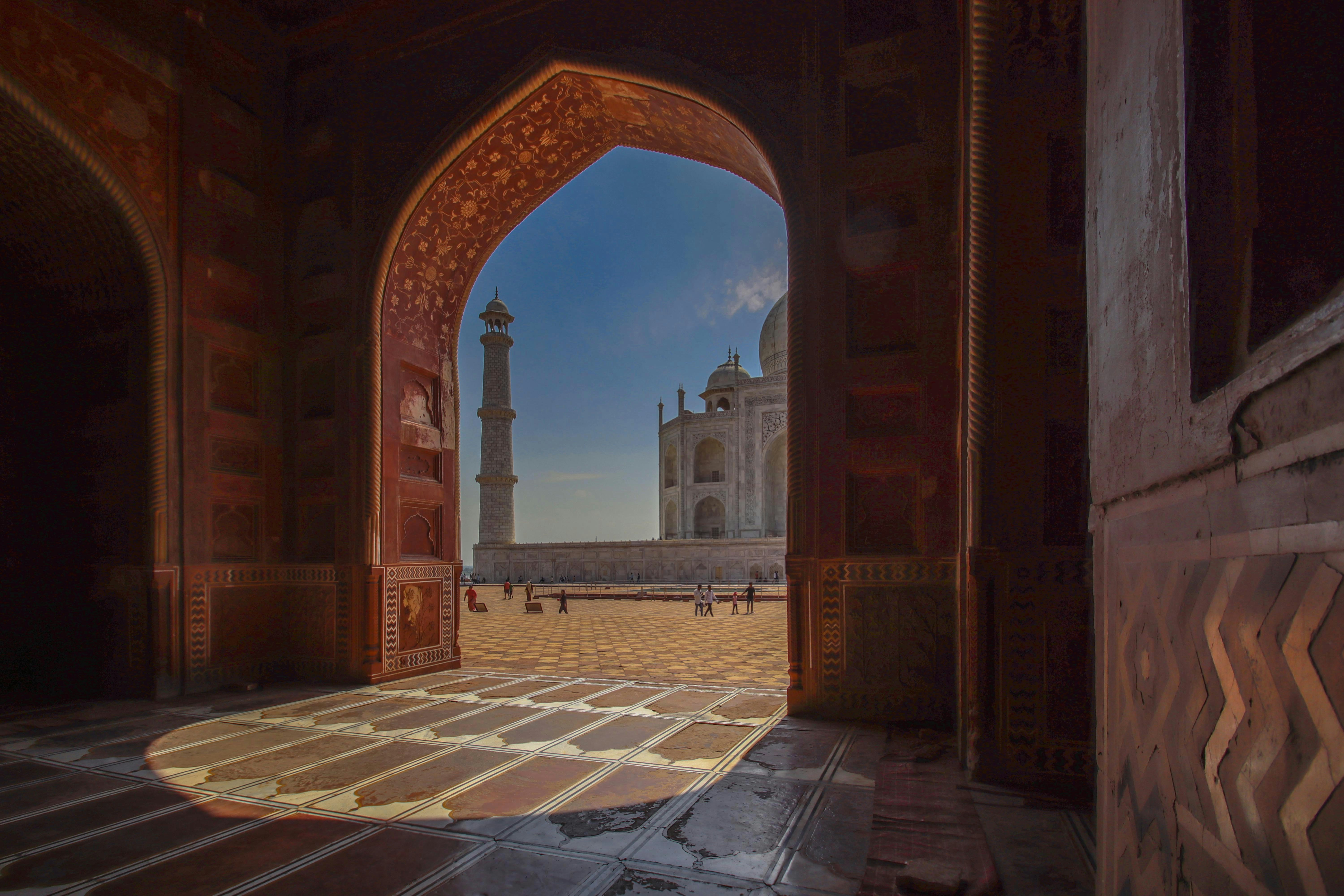 Archway of Light: Framing a Sunlit Courtyard Beyond the Shadowed Interior