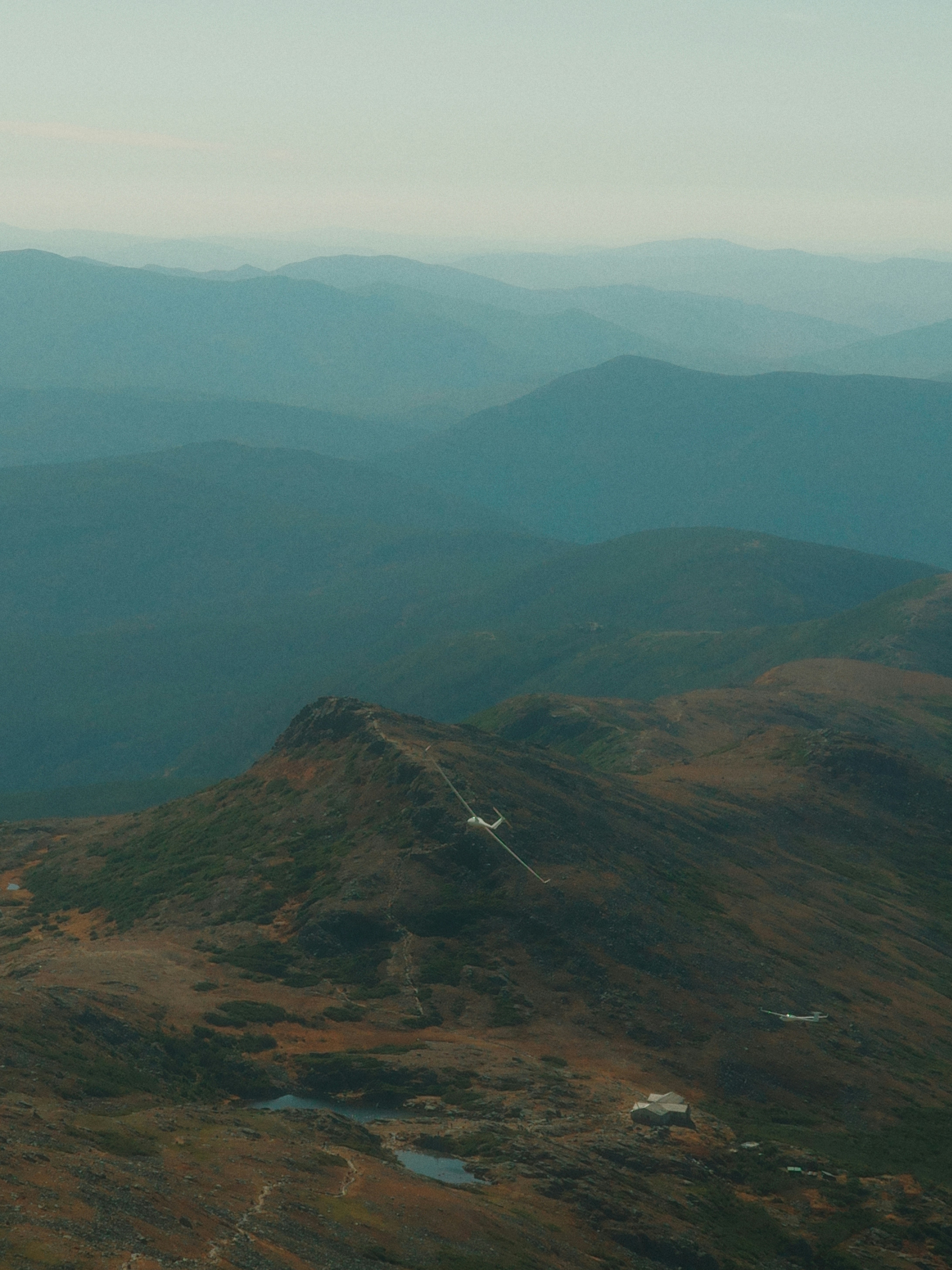 Ridge Line: The Ropeway Traces a Quiet Arc Across a Misty Mountain Range