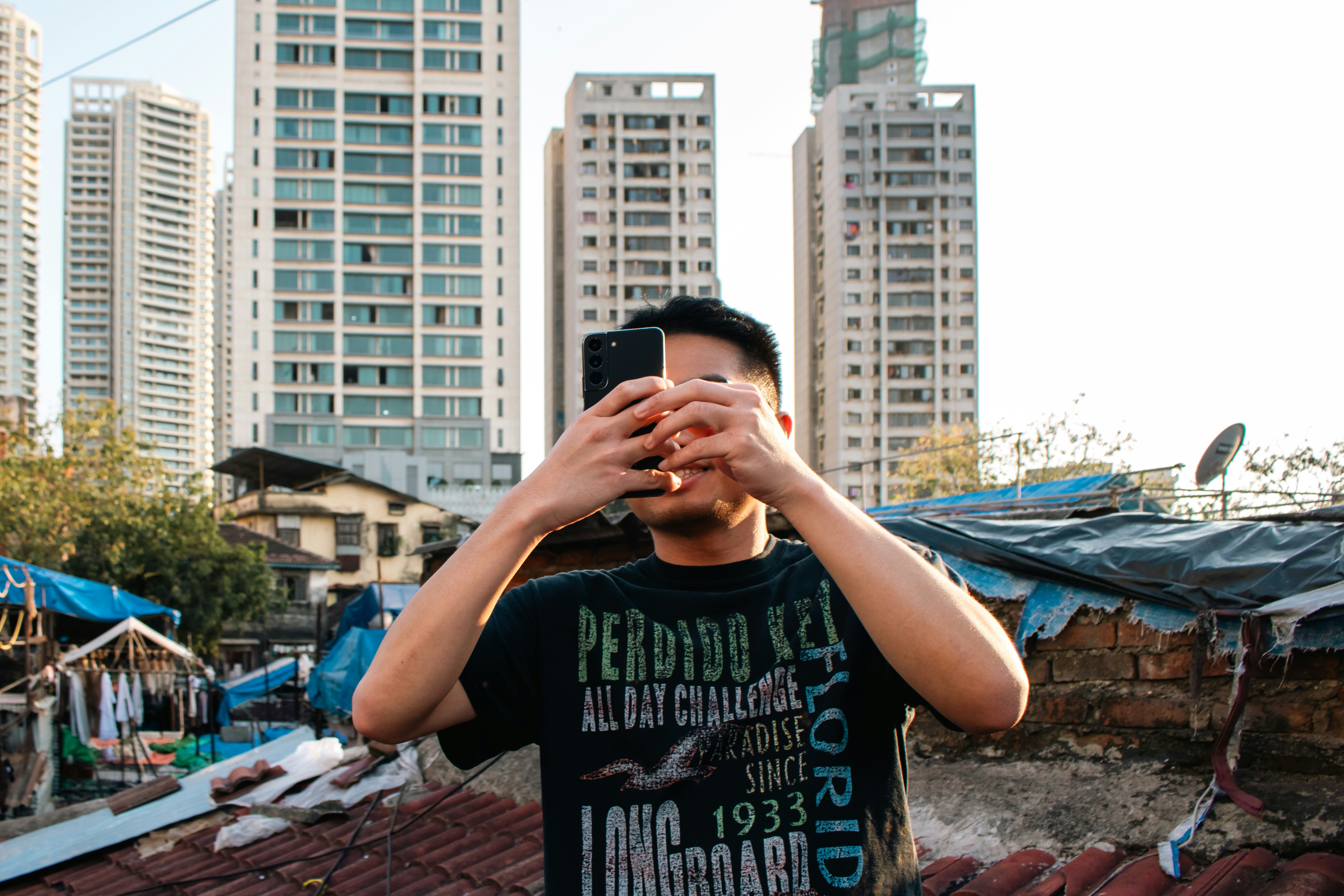 Selfie under the city’s towers: hands framing a skyline portrait