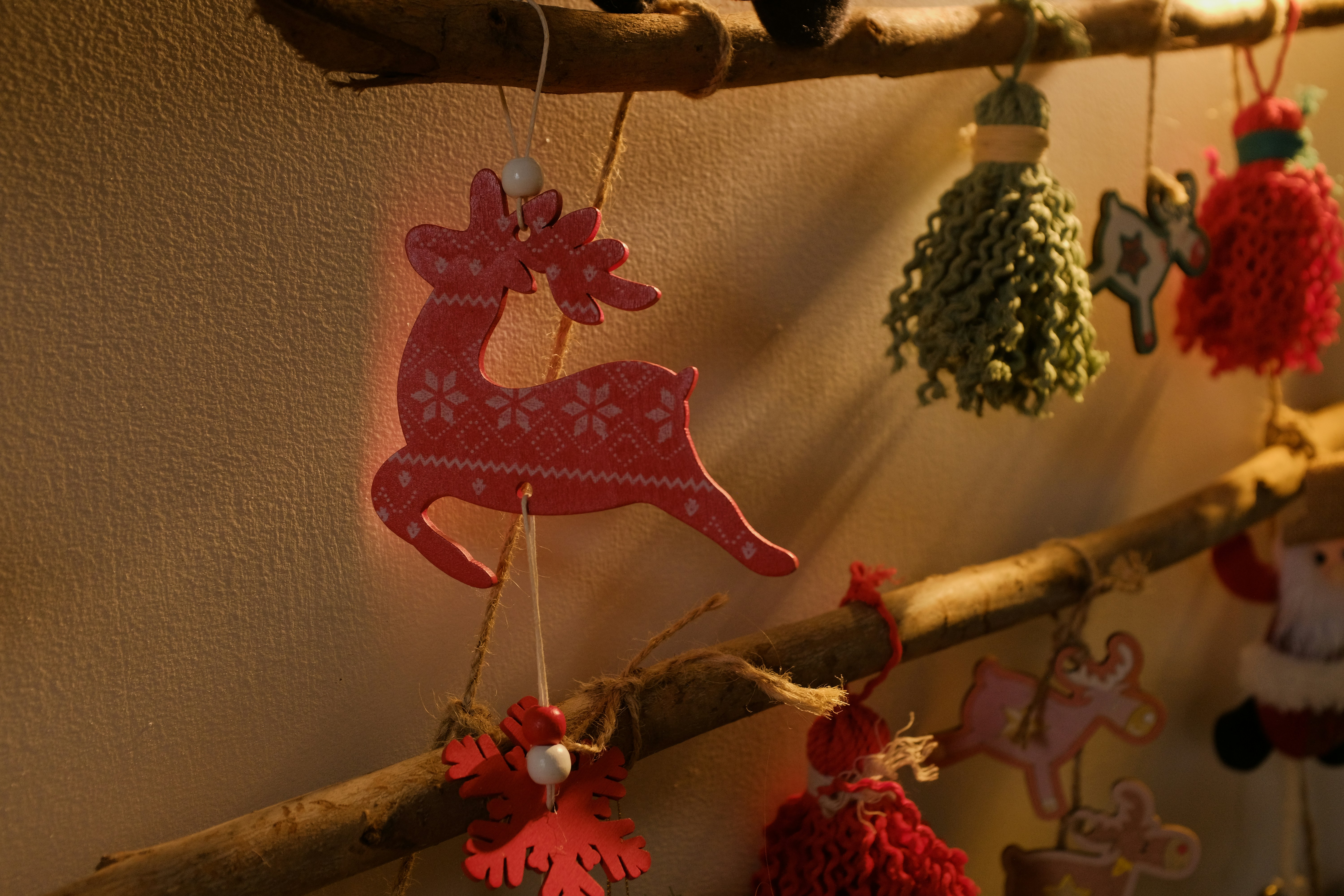 A Felt Reindeer Dangles Under Warm Holiday Glow