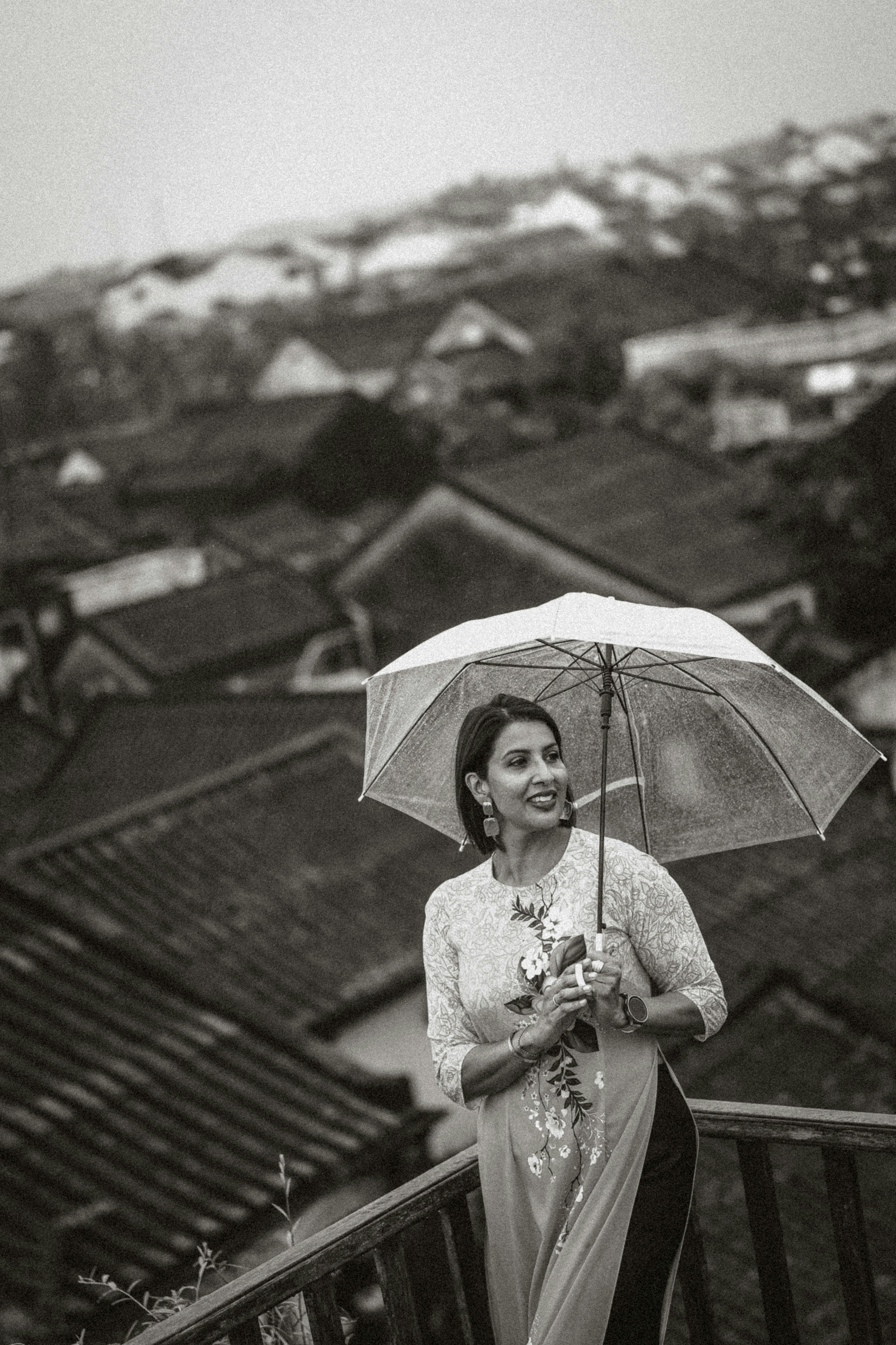 Lace, Umbrella, and the Quiet Village Below