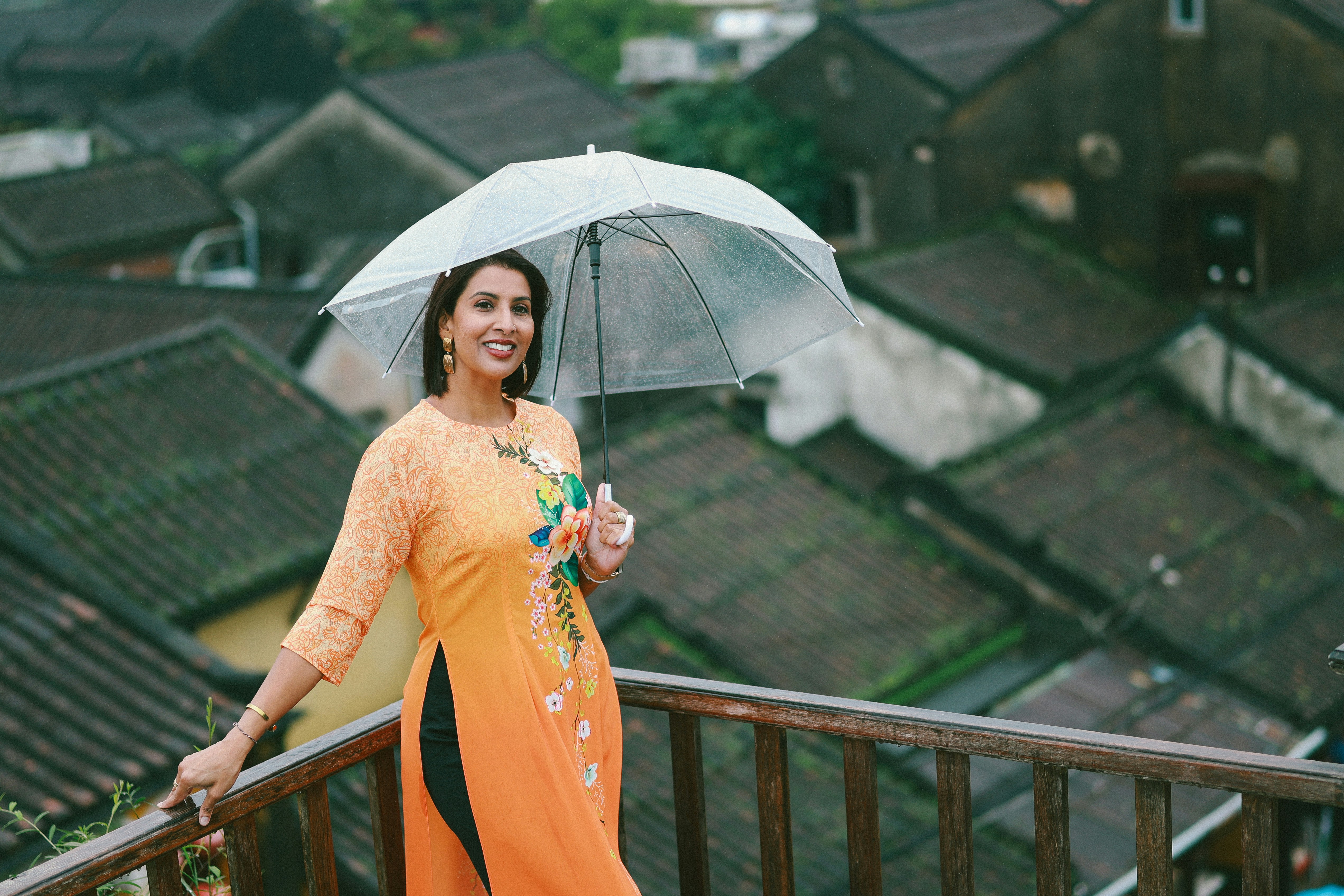 Amber áo dài Beneath a Silver Umbrella Over Rain-Kissed Rooftops