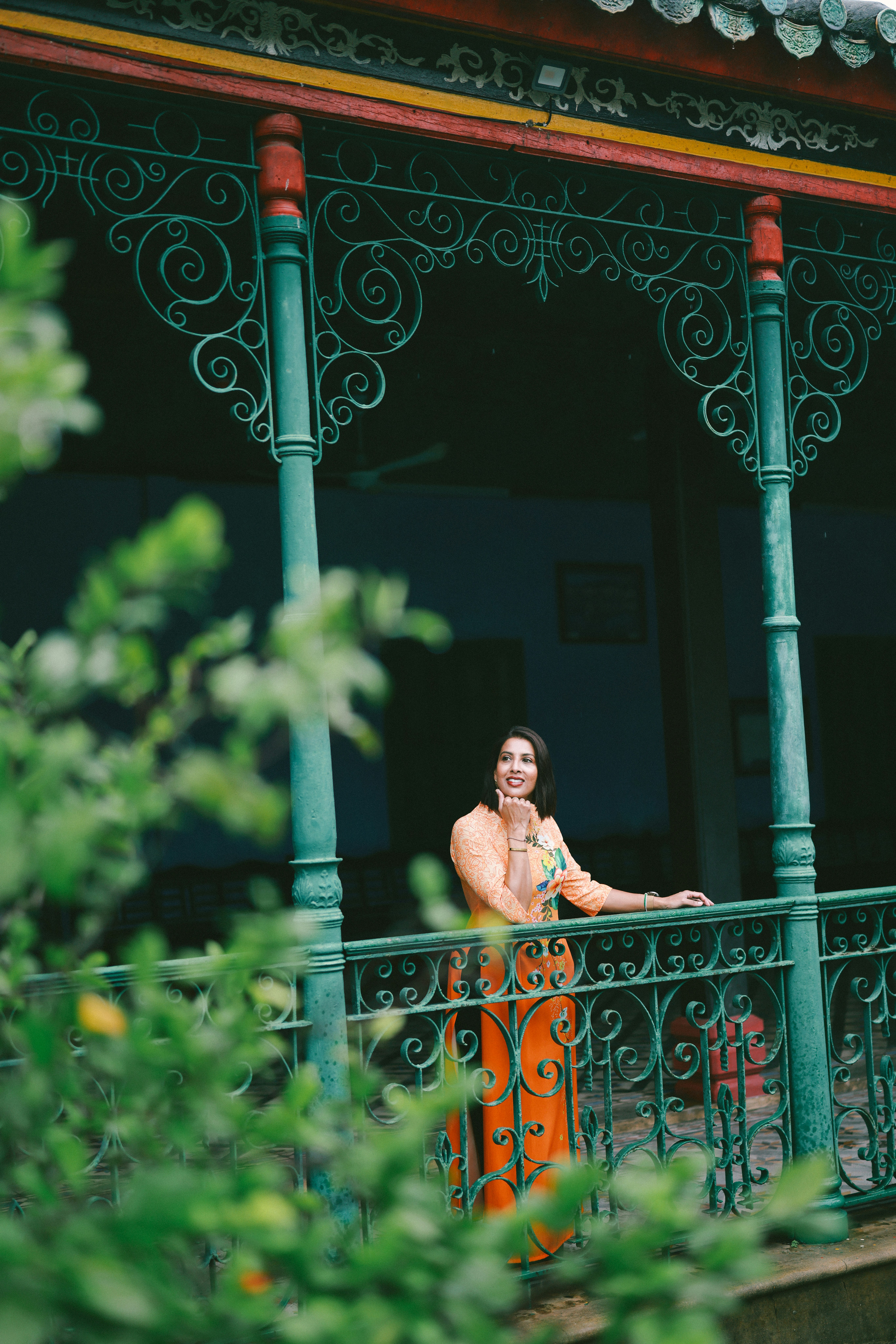 On the Teal Veranda: A Warm Smile Among Iron Scrolls