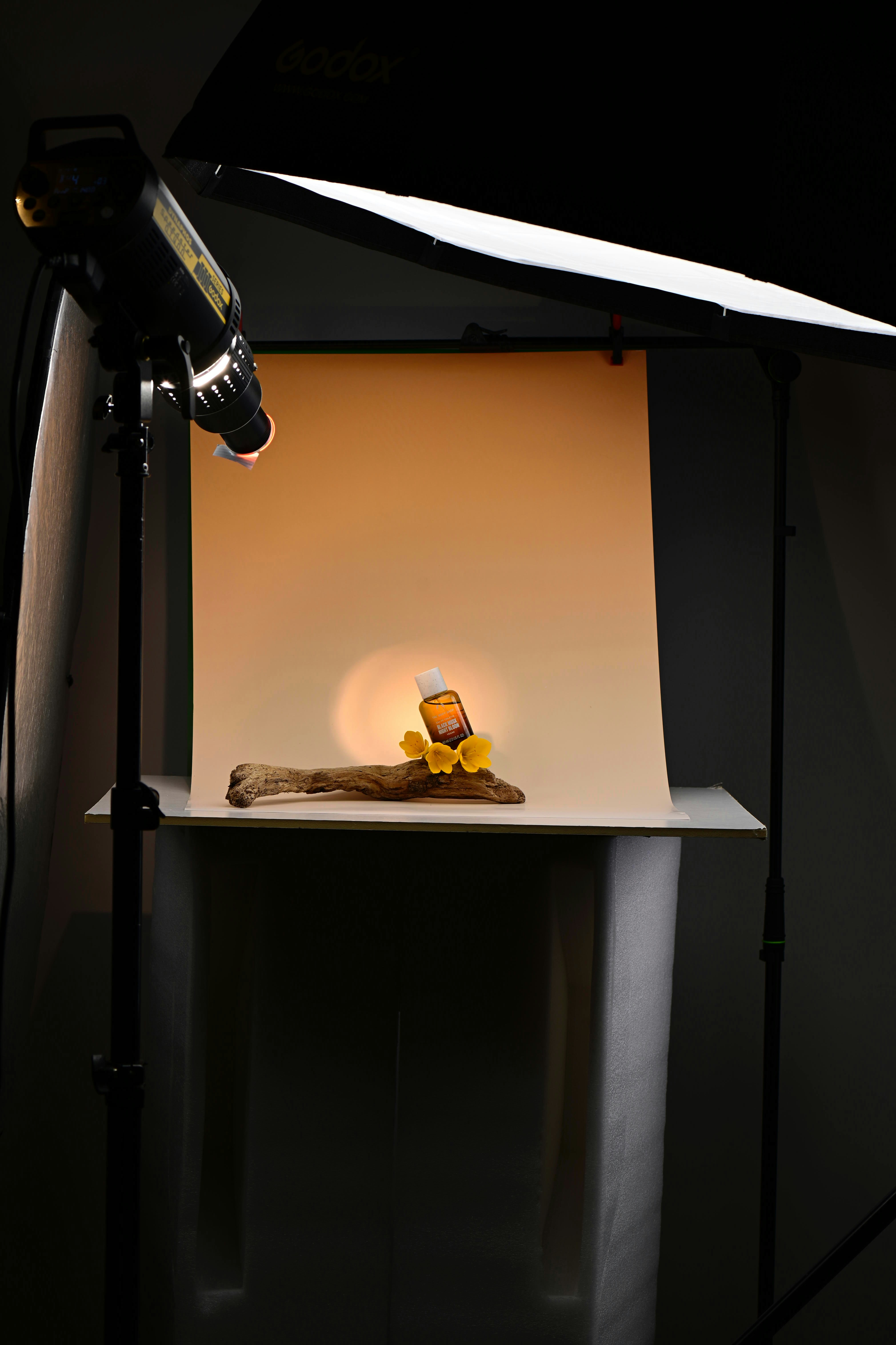 Amber Glow: Candle, Bottle, and Drift on a Studio Stage