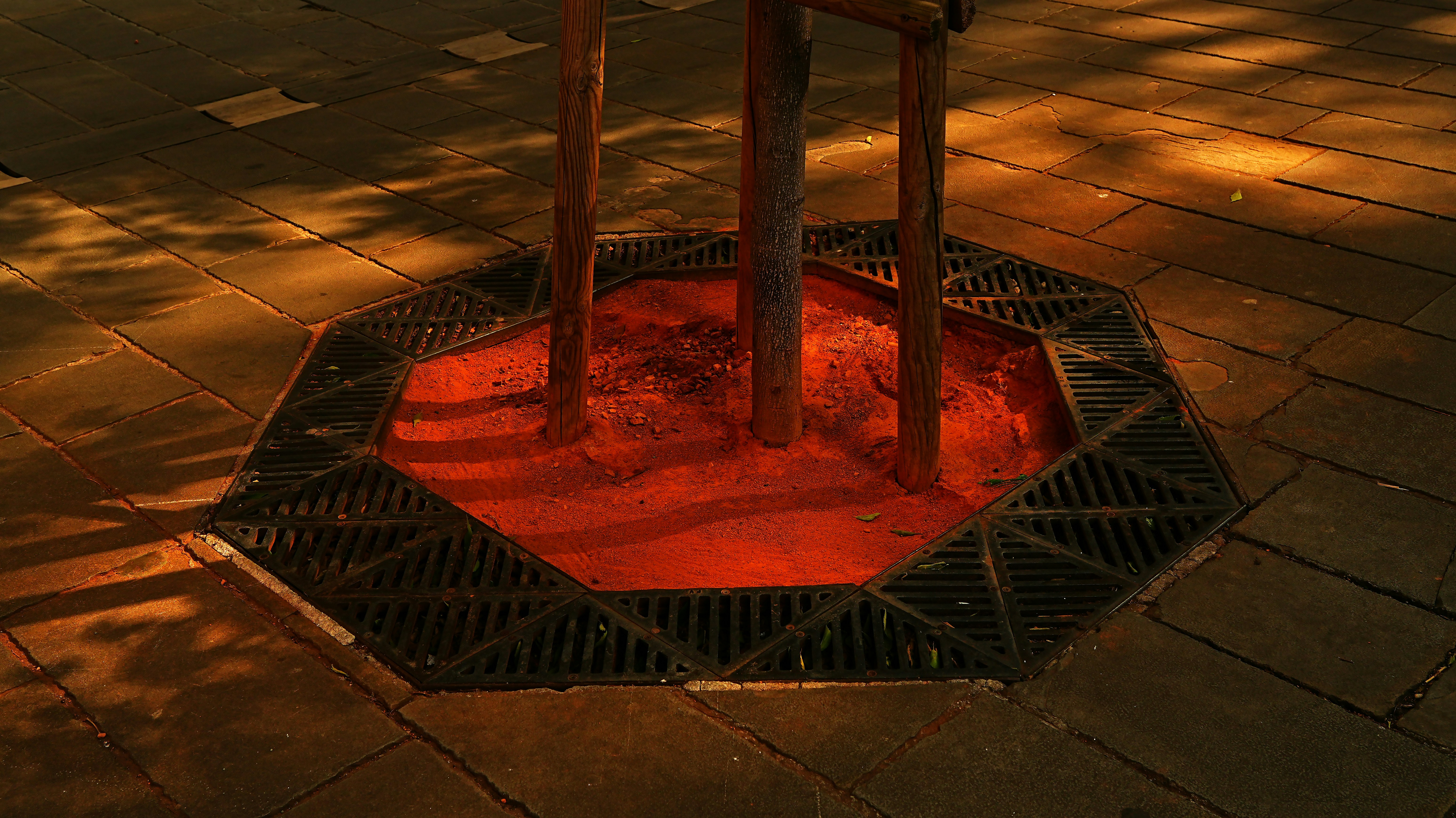Crimson Center: Hexagonal Ring of Light in a Warm Cobblestone Plaza