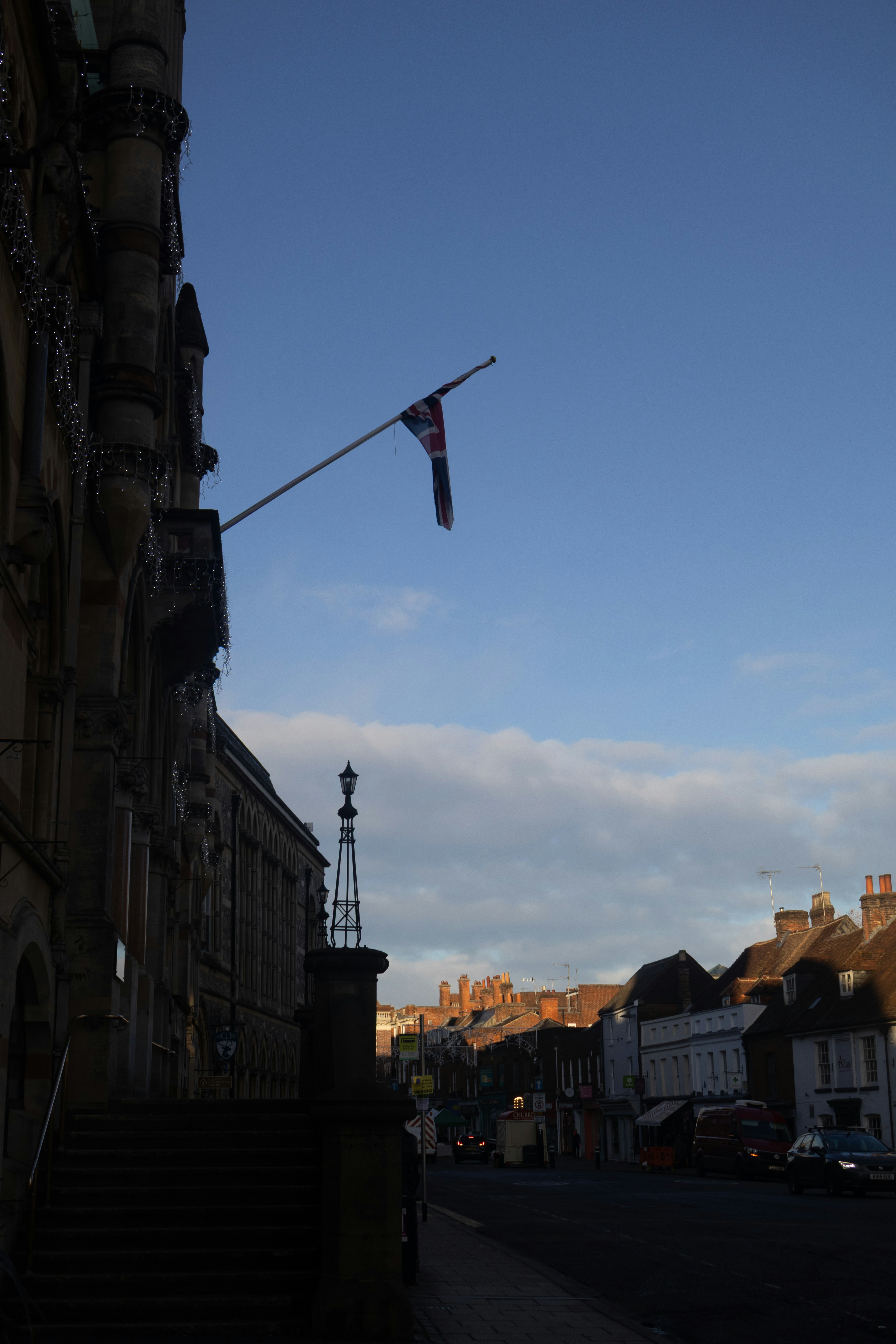 Flag on a Quiet City Street under a Clear Blue Sky