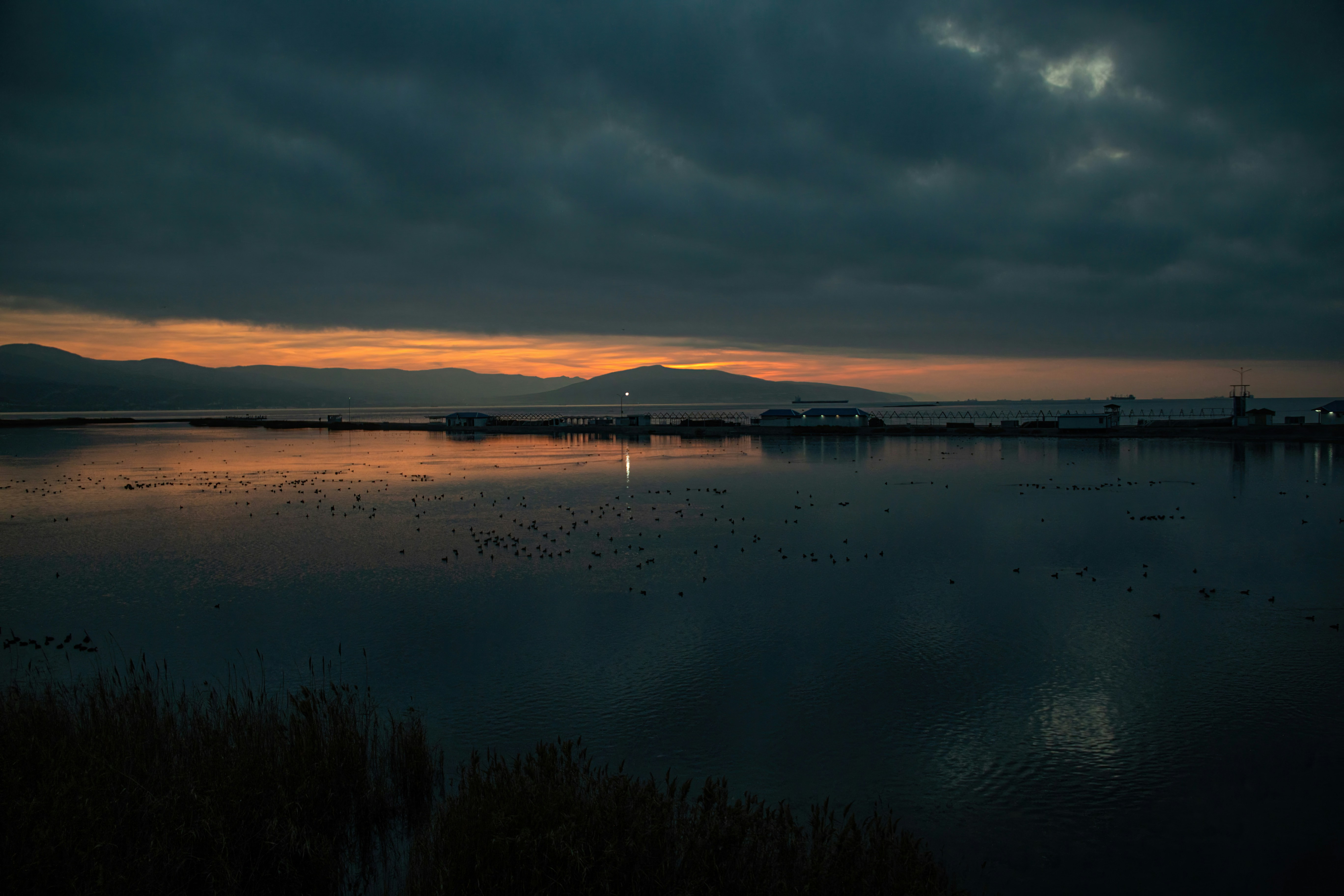 Horizon Ember over a Quiet Marina at Dusk