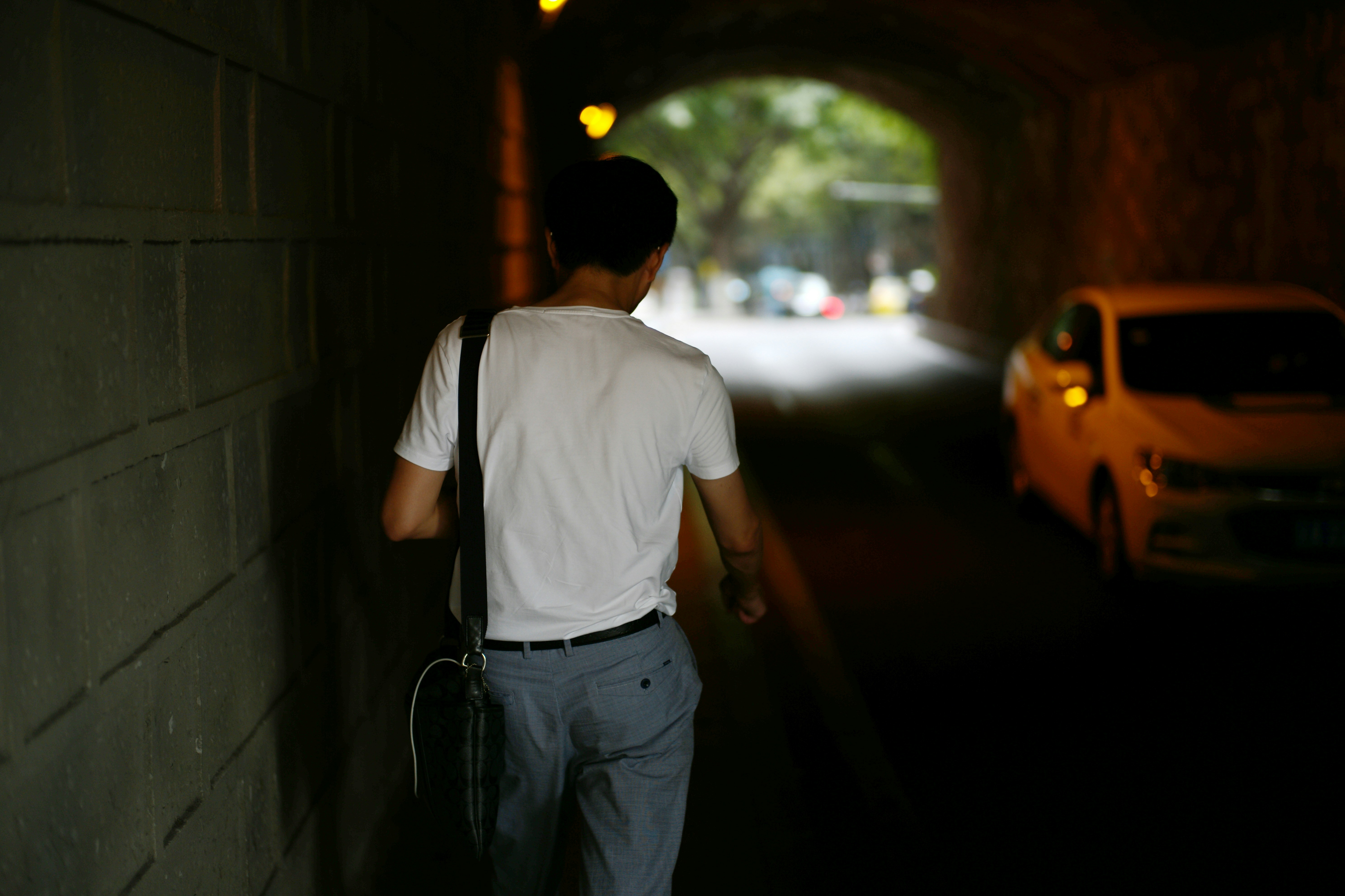 Back to the Light: A Lone Figure Steps Through the Shadowed Tunnel