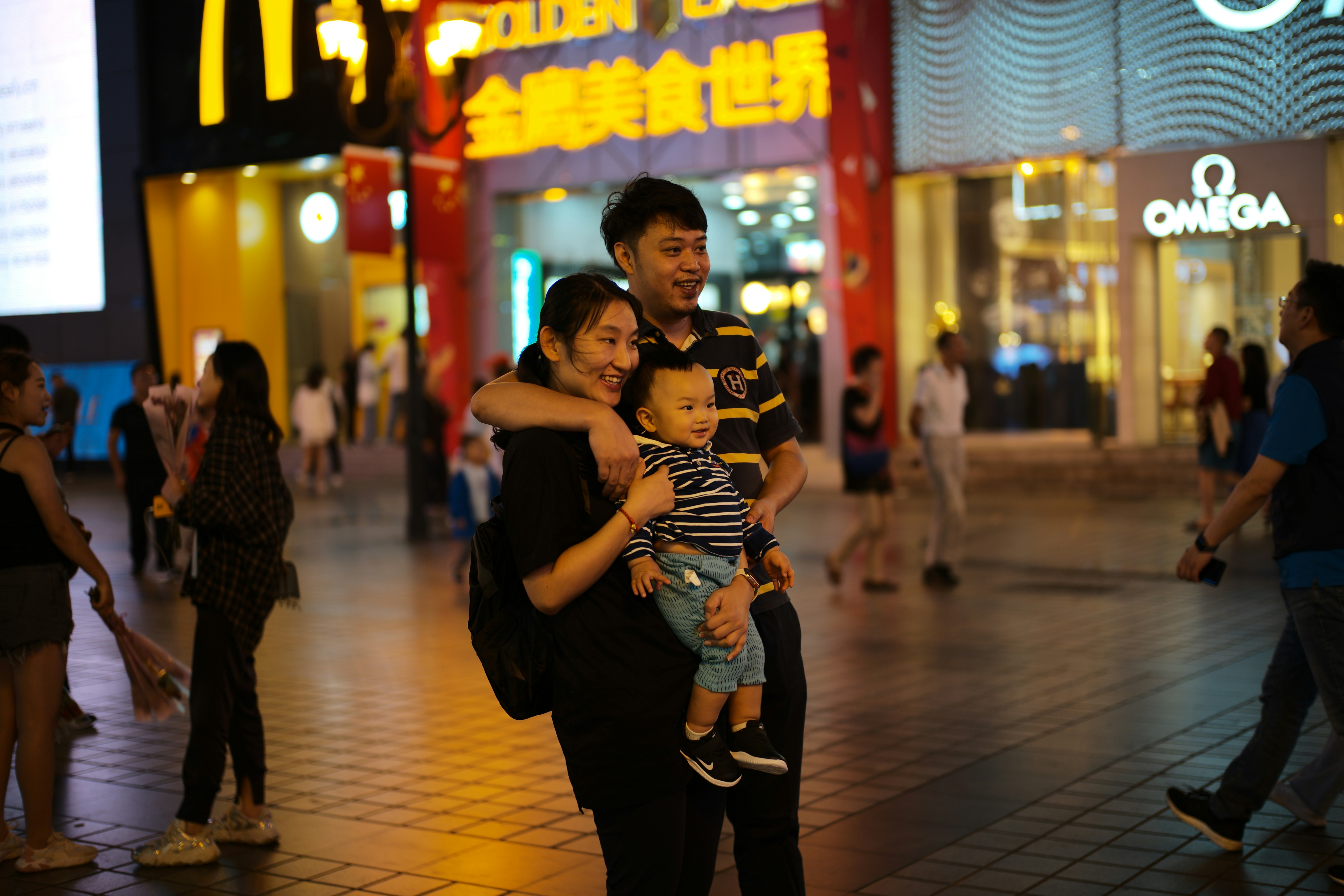 Neon Echoes in a City Square: A Family's Night Lift