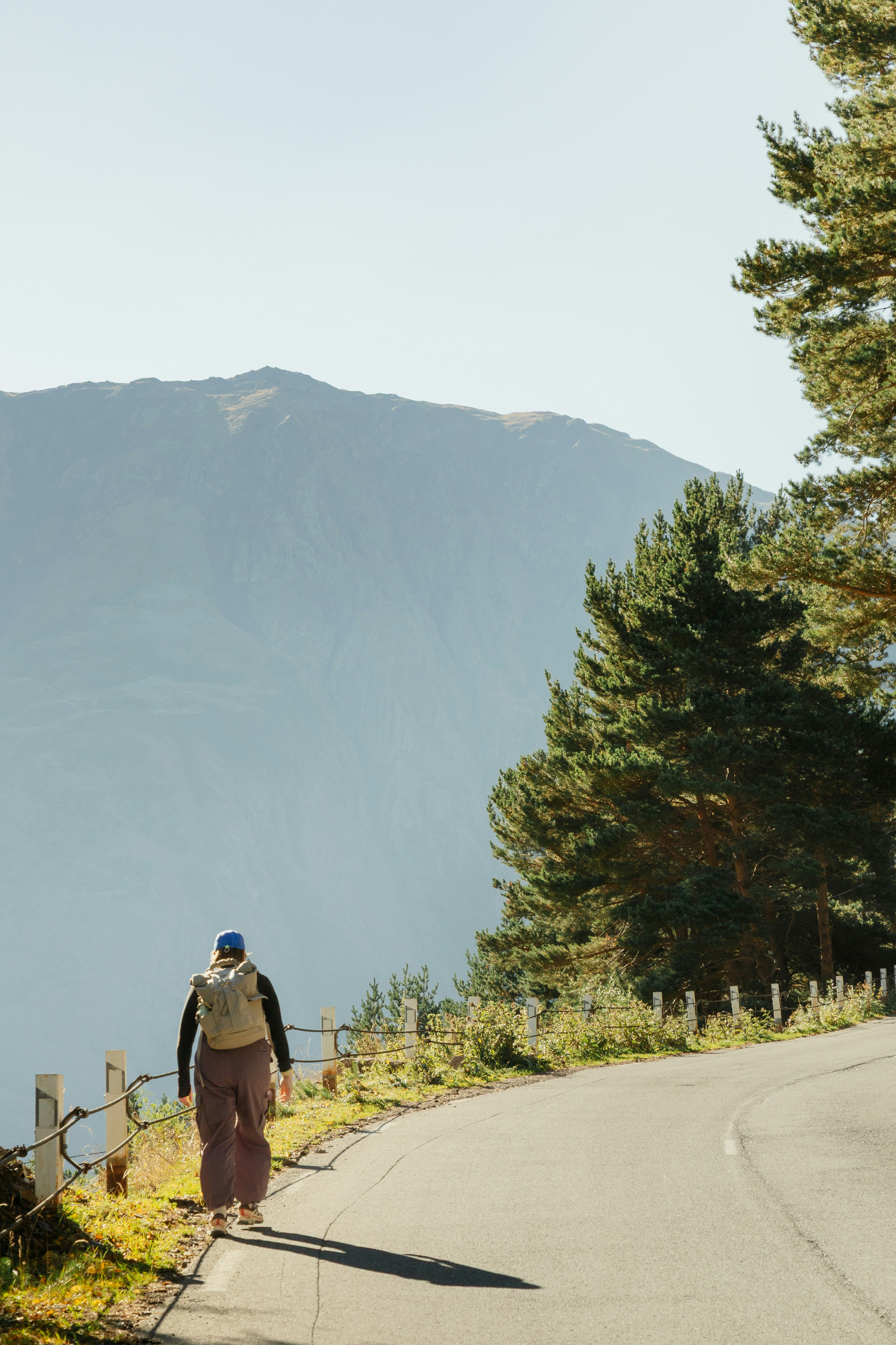 Lone Hiker on a Winding Alpine Road