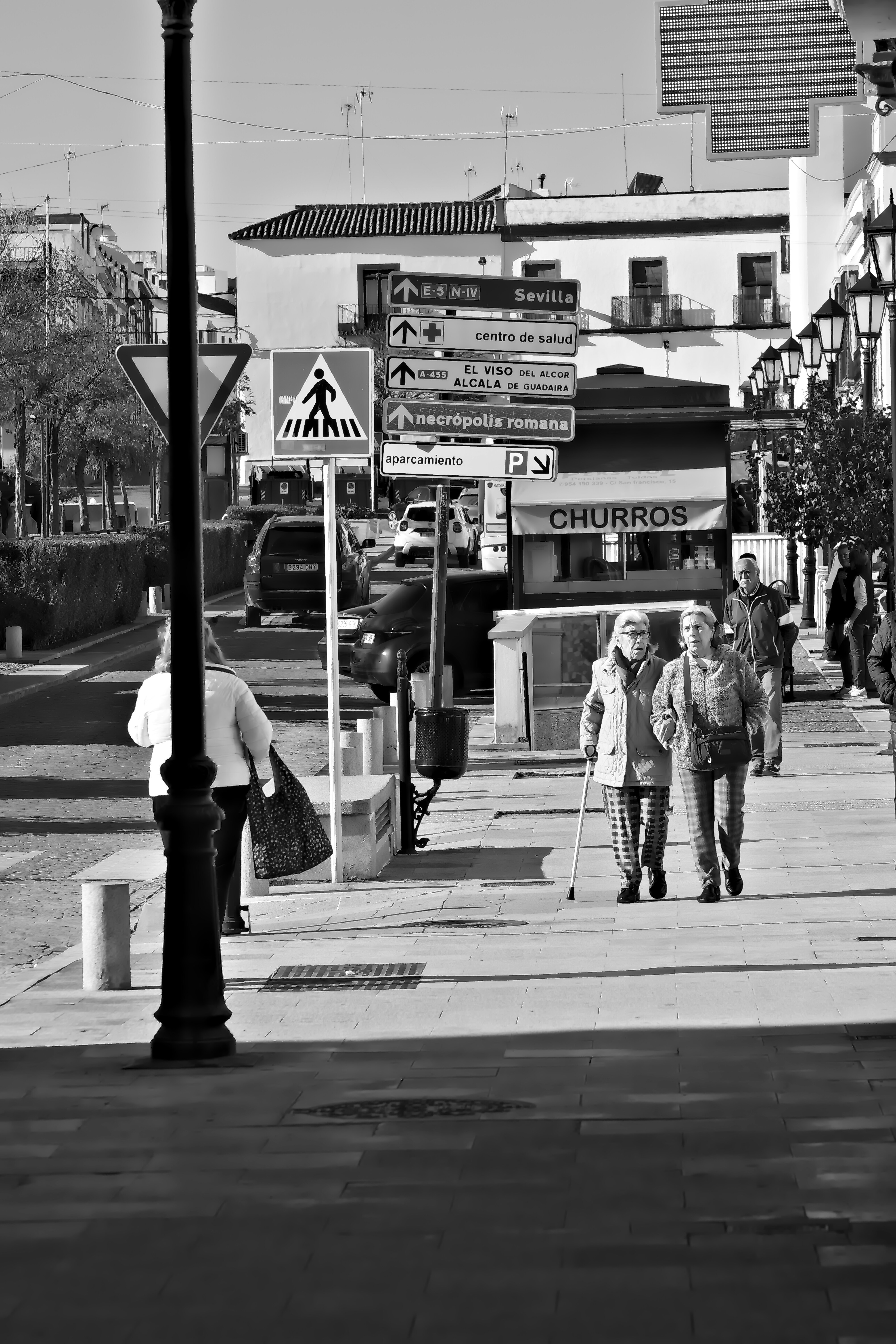 these arepeople in the street by a kiosk of fritters