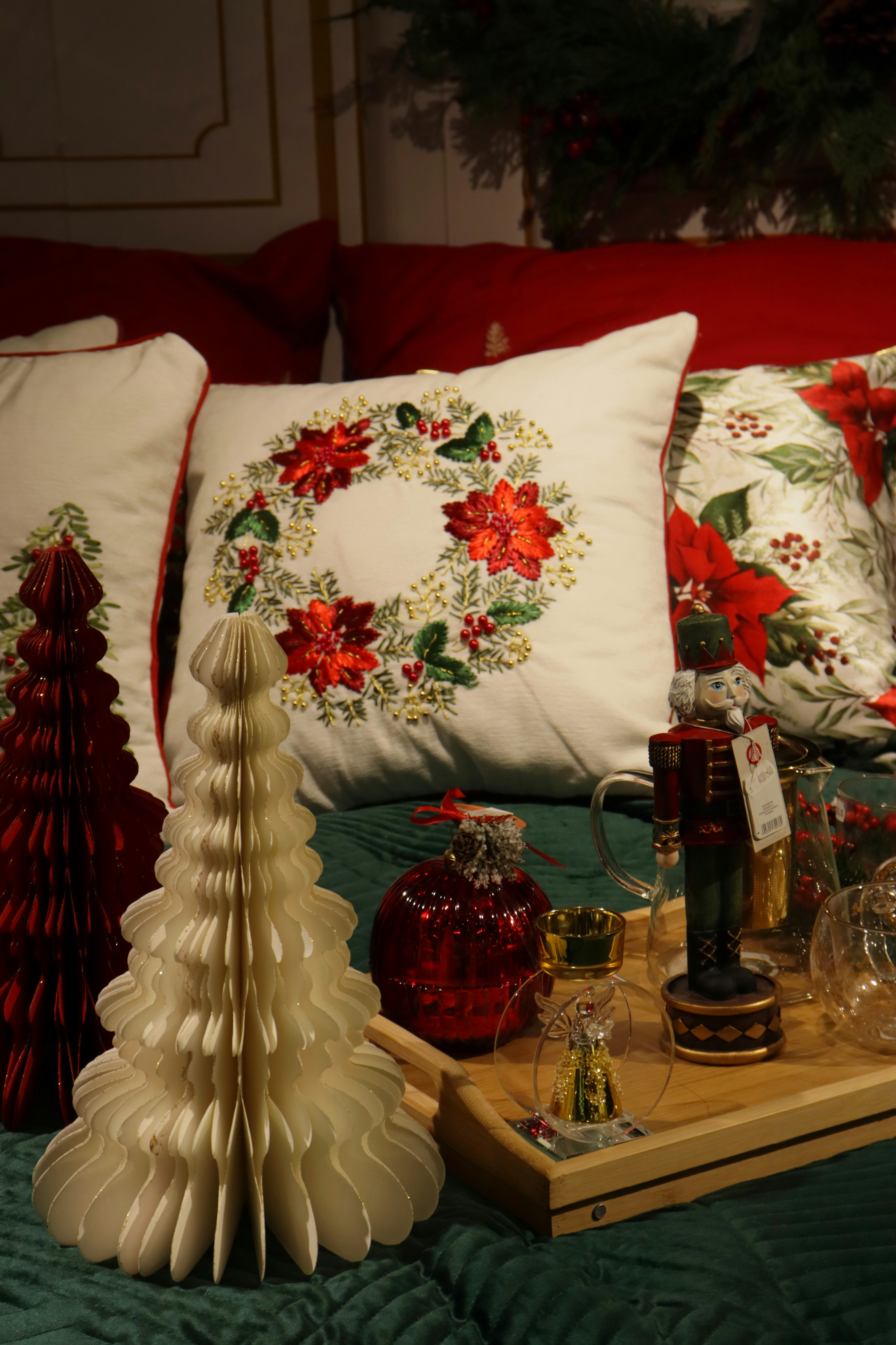 Holiday Still Life: Christmas Ornaments and Wreath Cushioned by Pillowy Cushions