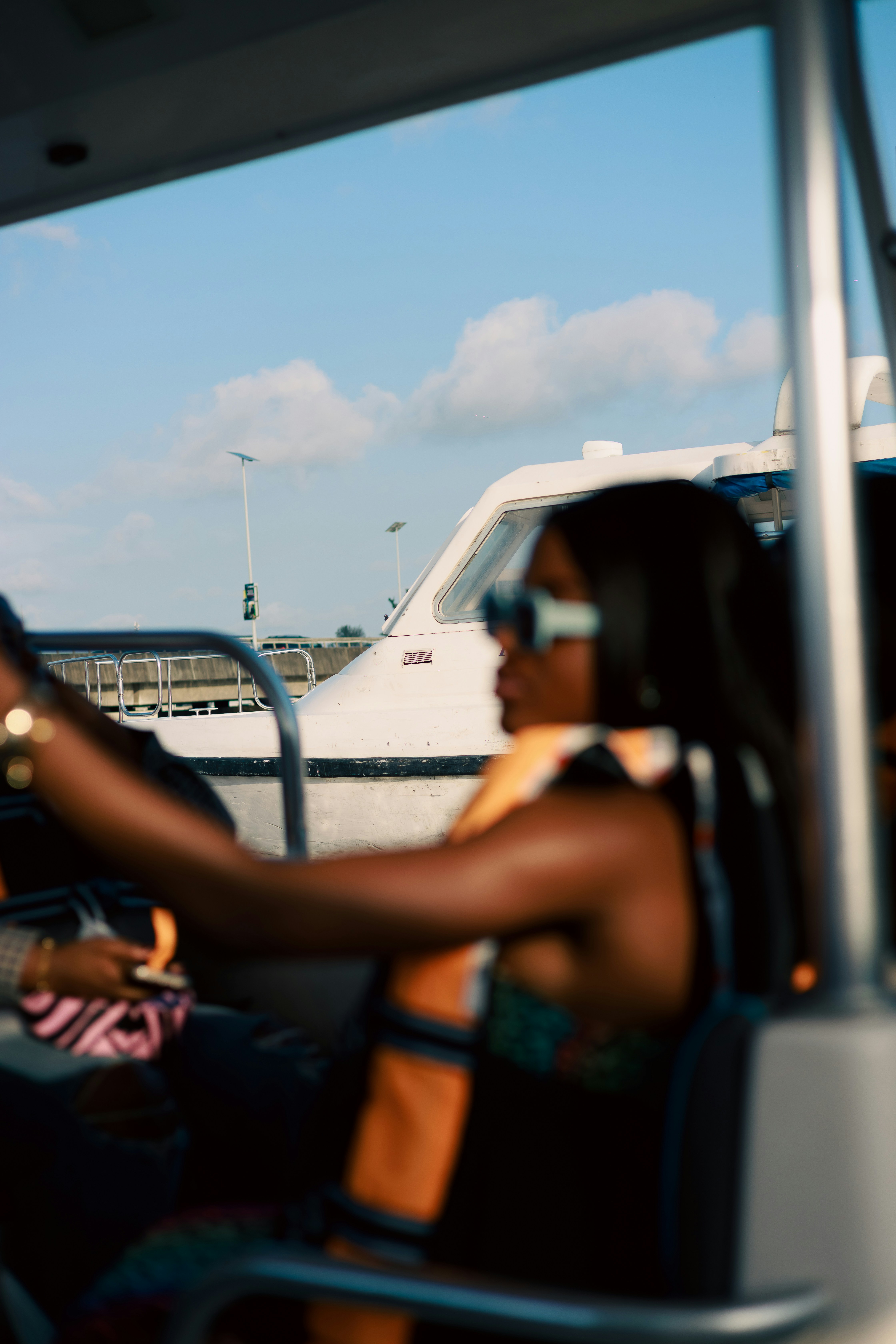 Orange Life Jacket on a Sunlit Ferry: A Quiet Moment