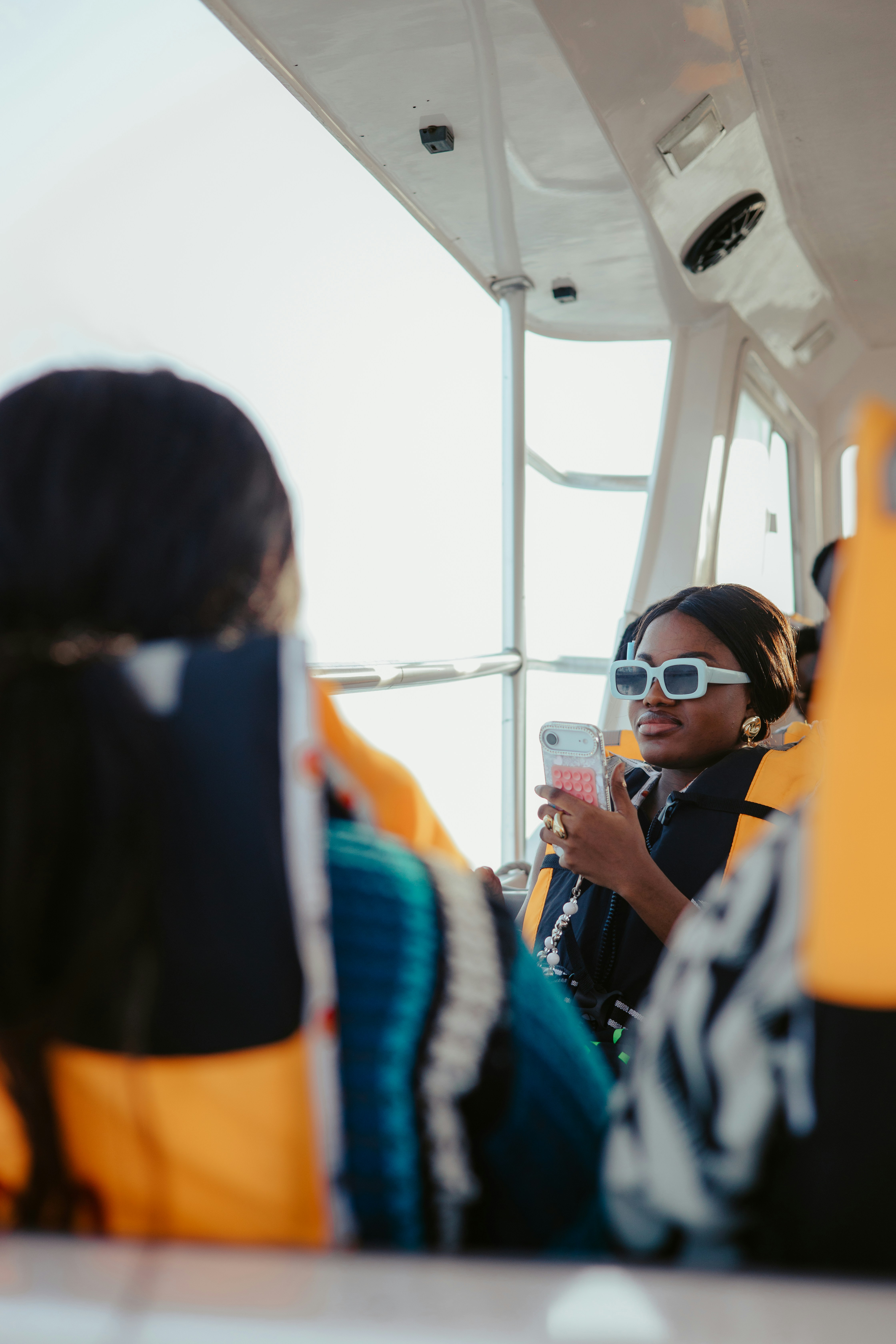 Sunlit Ferry Moment: White Frames and a Focused Gaze