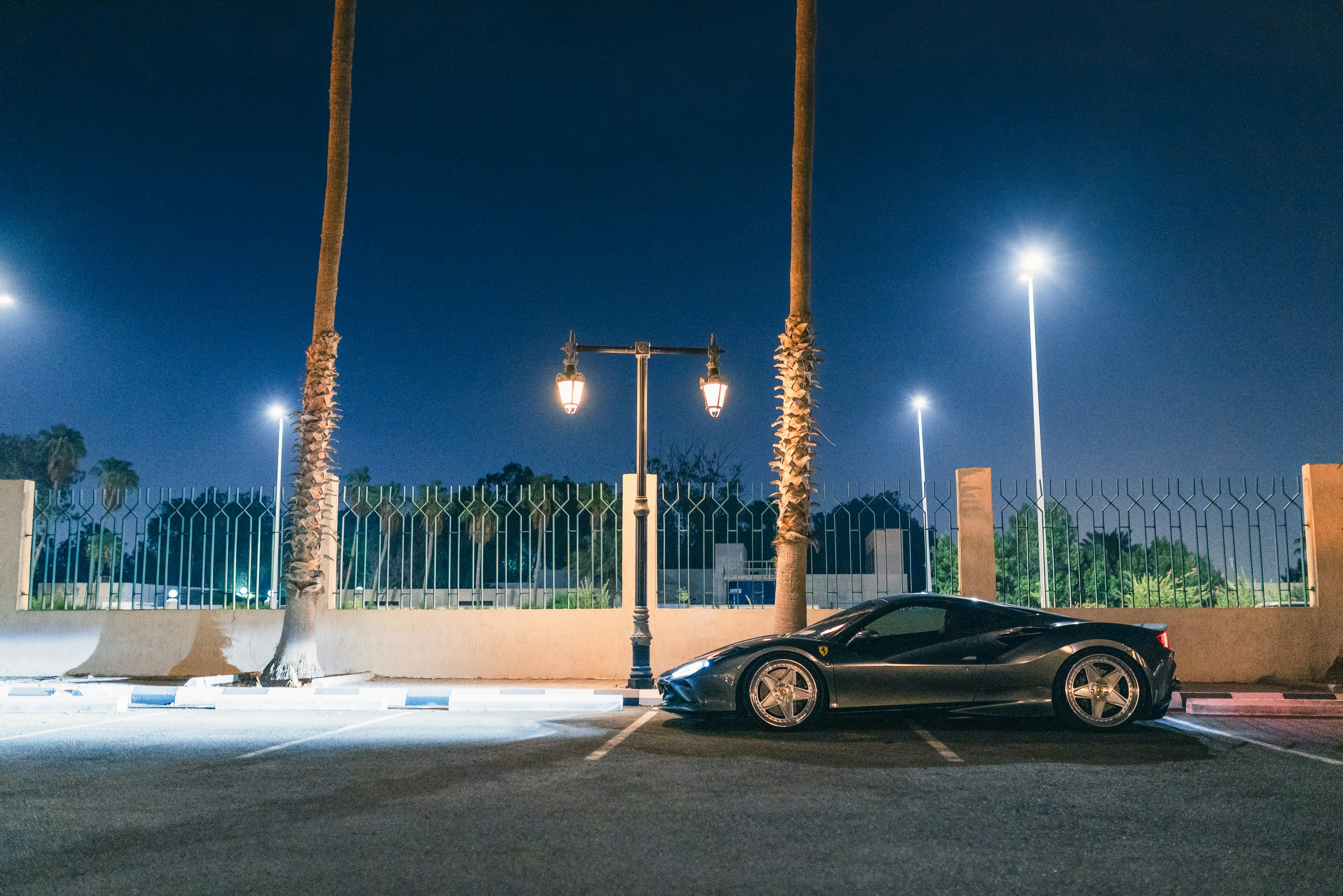 Low Night Drive: Sleek Black Muscle in Urban Nightscape