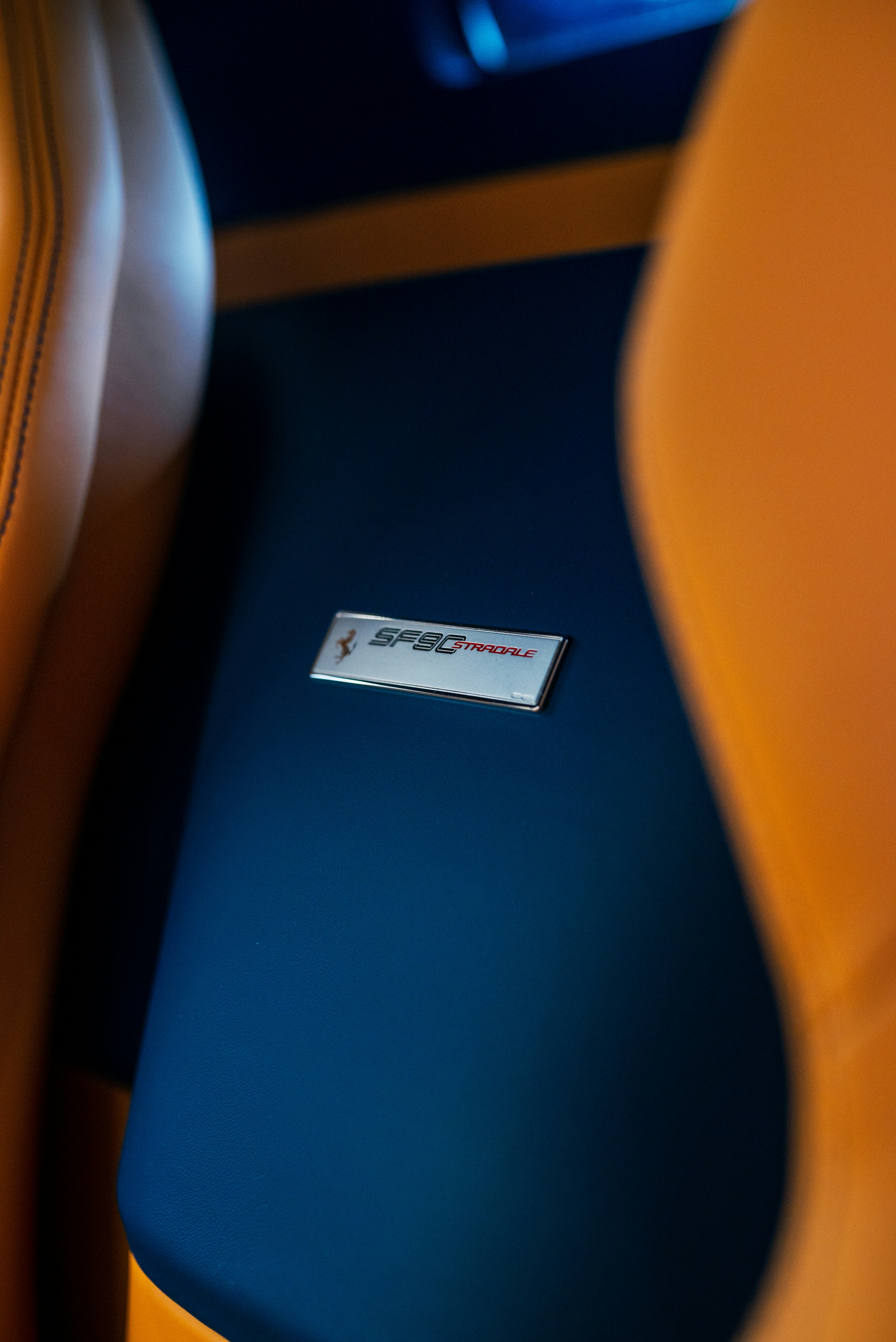 Blue Heart of Speed: SF90 Stradale Emblem Between Orange Seats