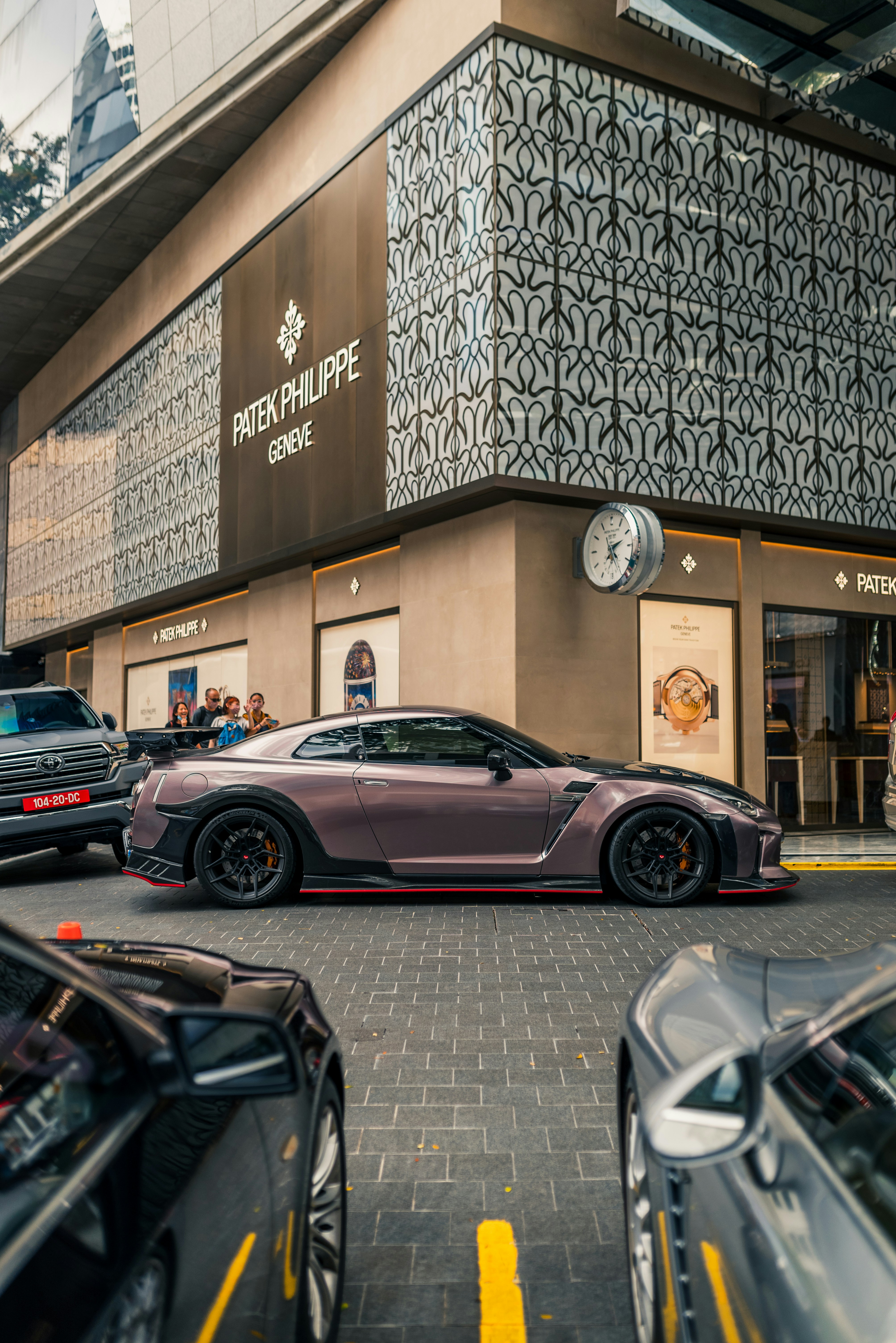 Violet Porsche Pauses in Front of a Patek Philippe Facade