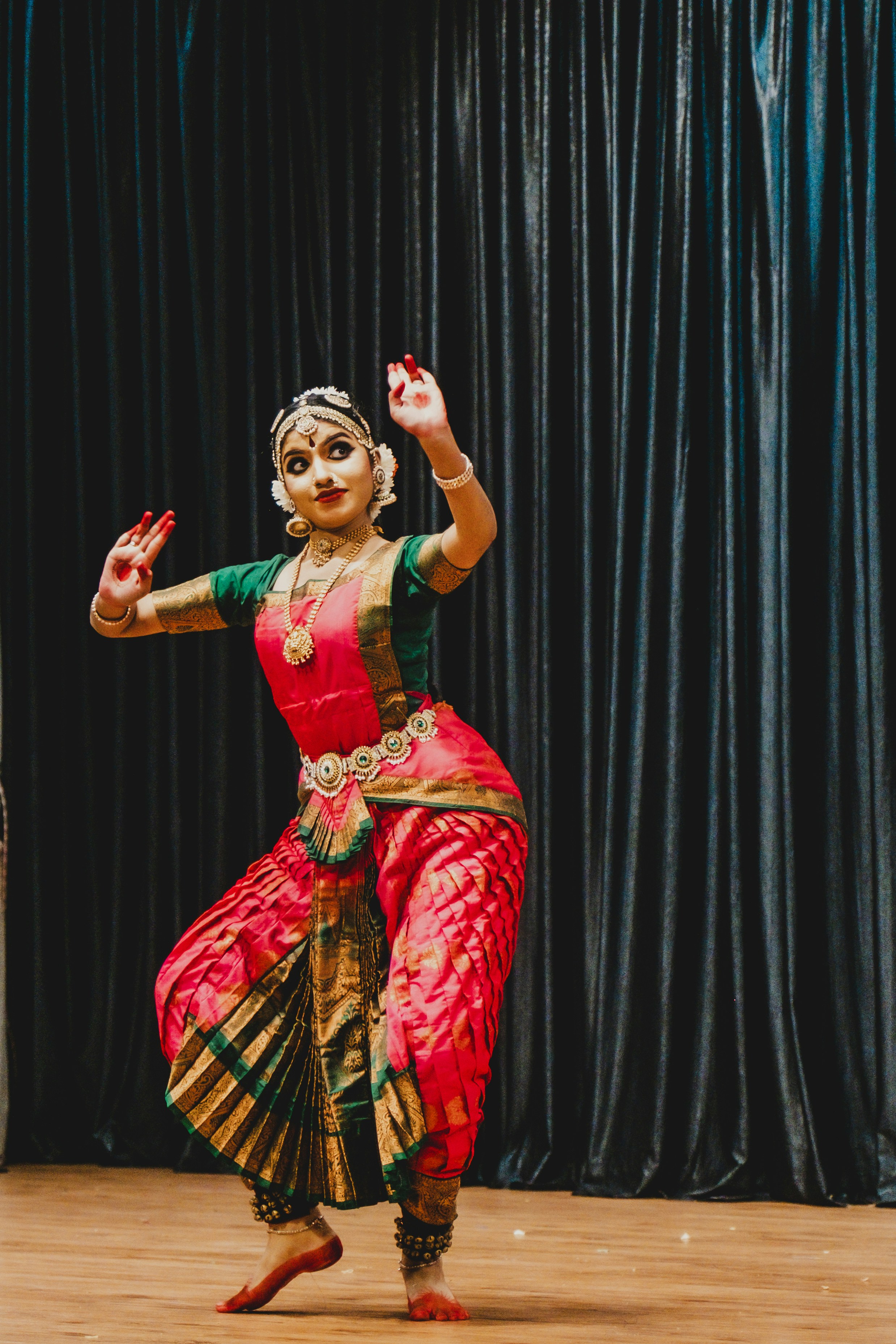 Crimson Silk in Motion: A Bharatanatyam Performance on Velvet Stage