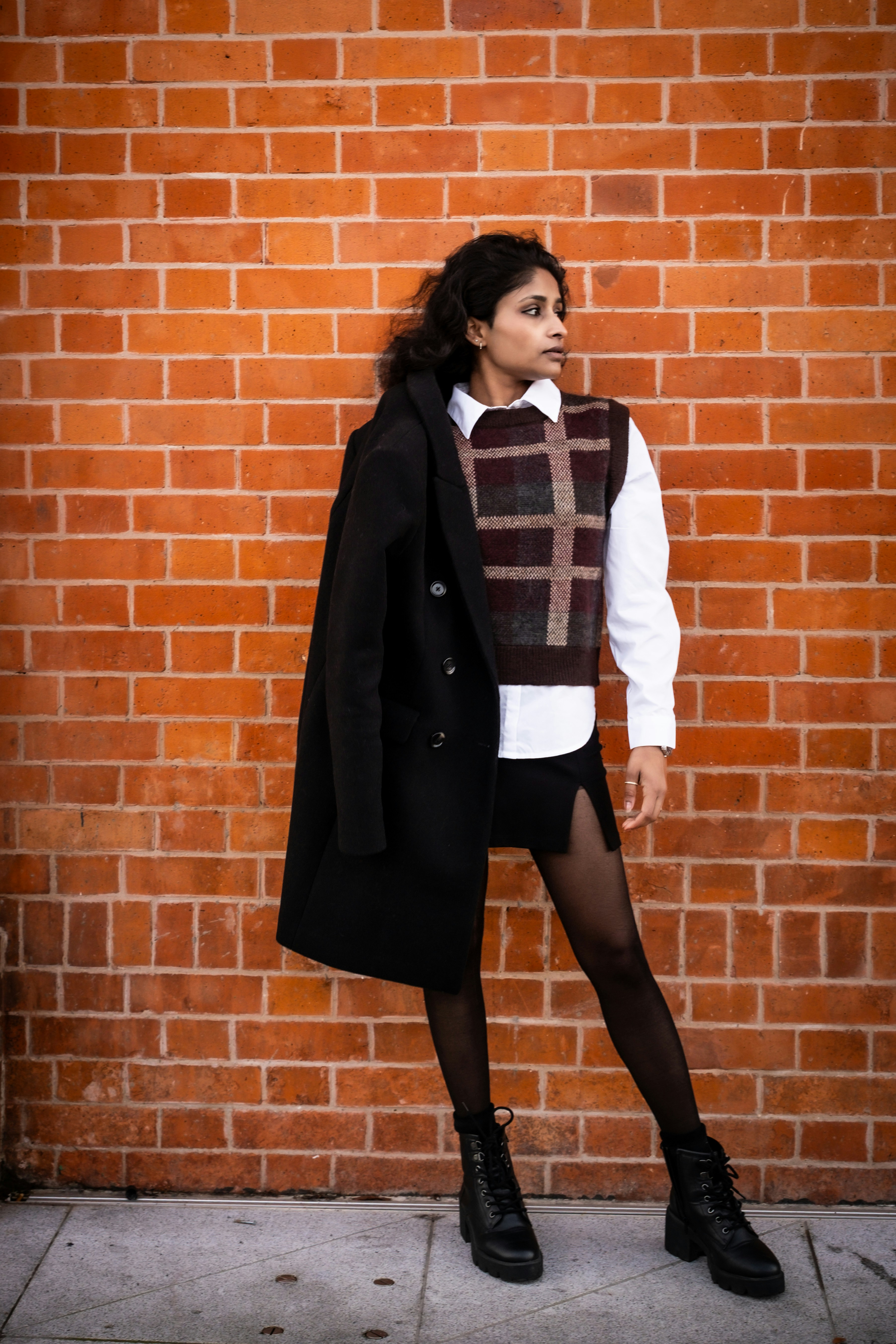 Brick Wall Confidence: A Fashioned Moment in the City Light