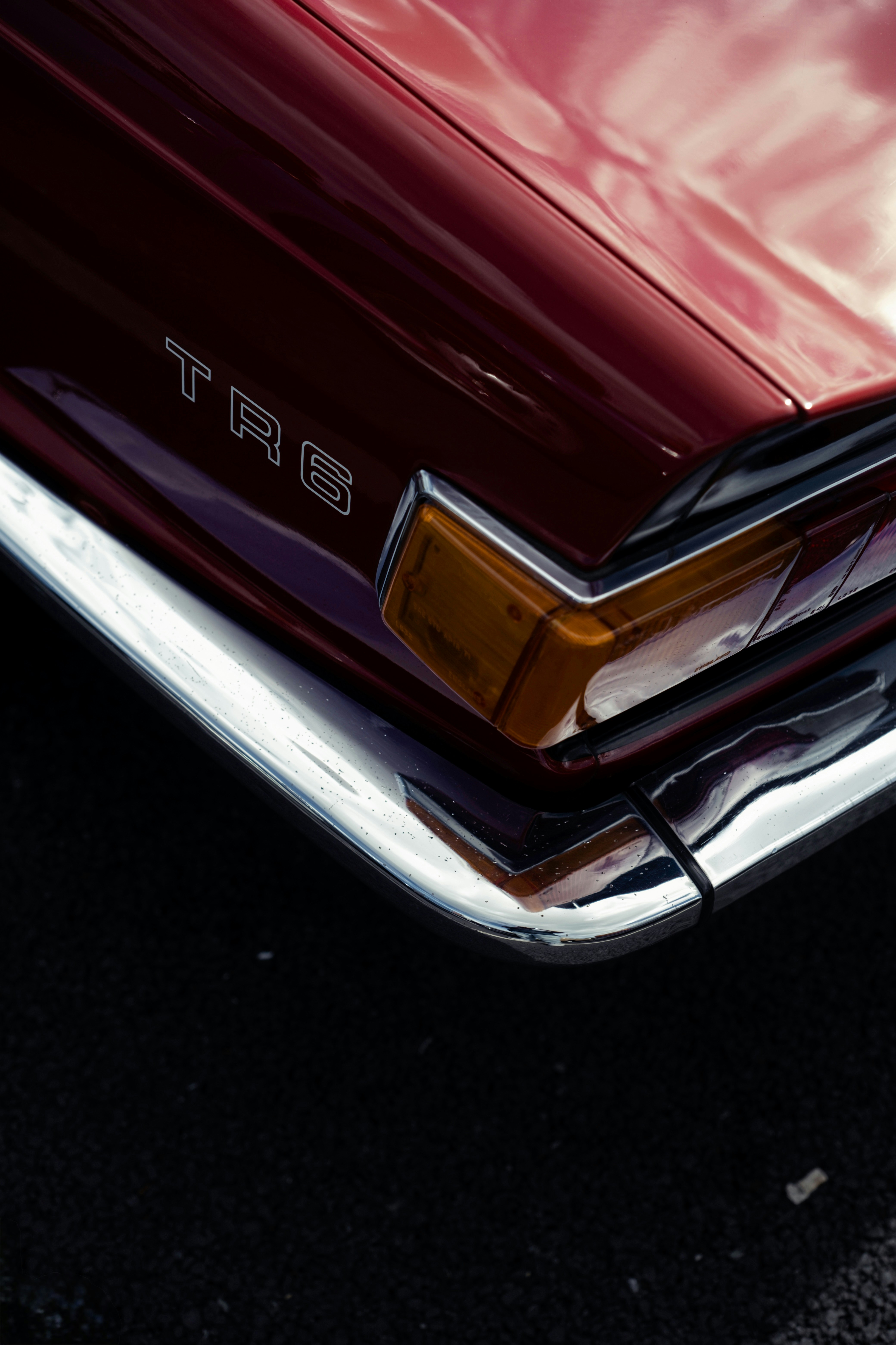 Crimson Edge: Triumph TR6 Badge at the Chrome Corner