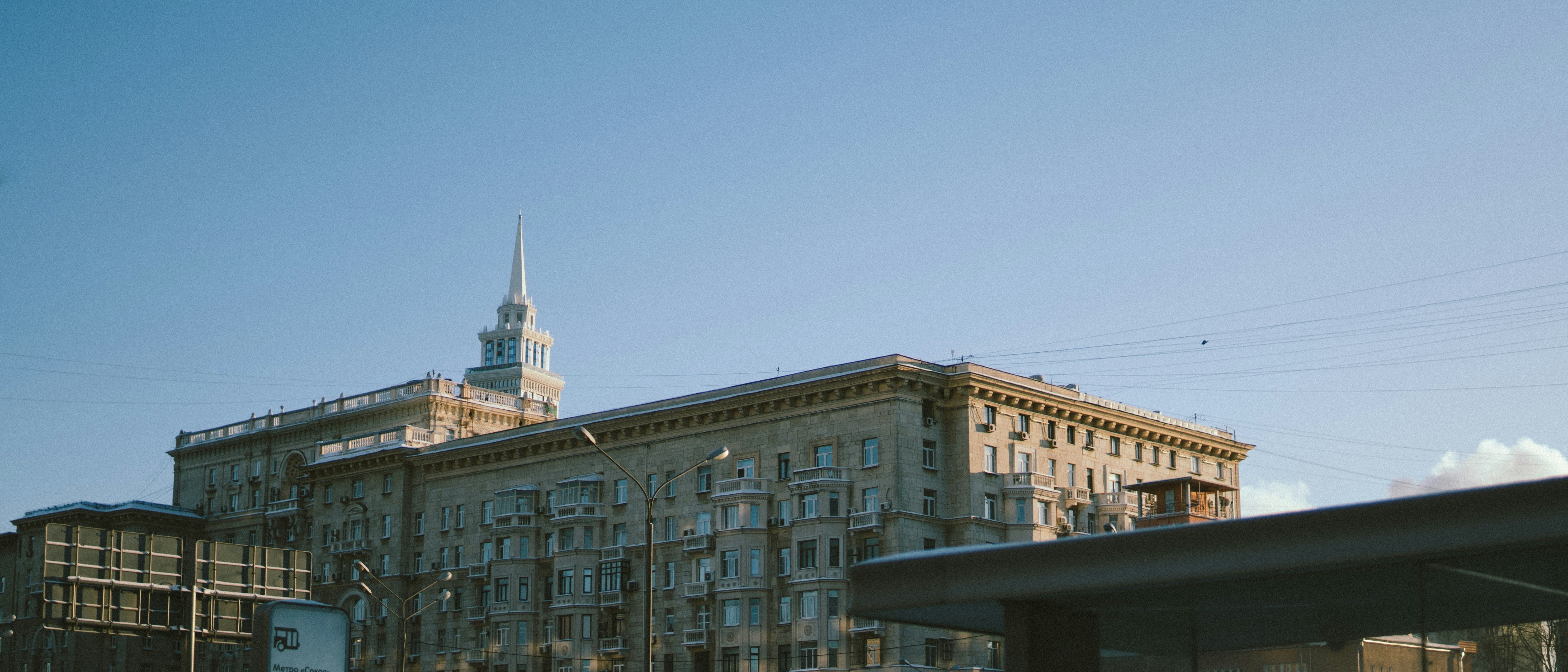 Spire and Brick Horizon: A City Block Under a Clear Sky