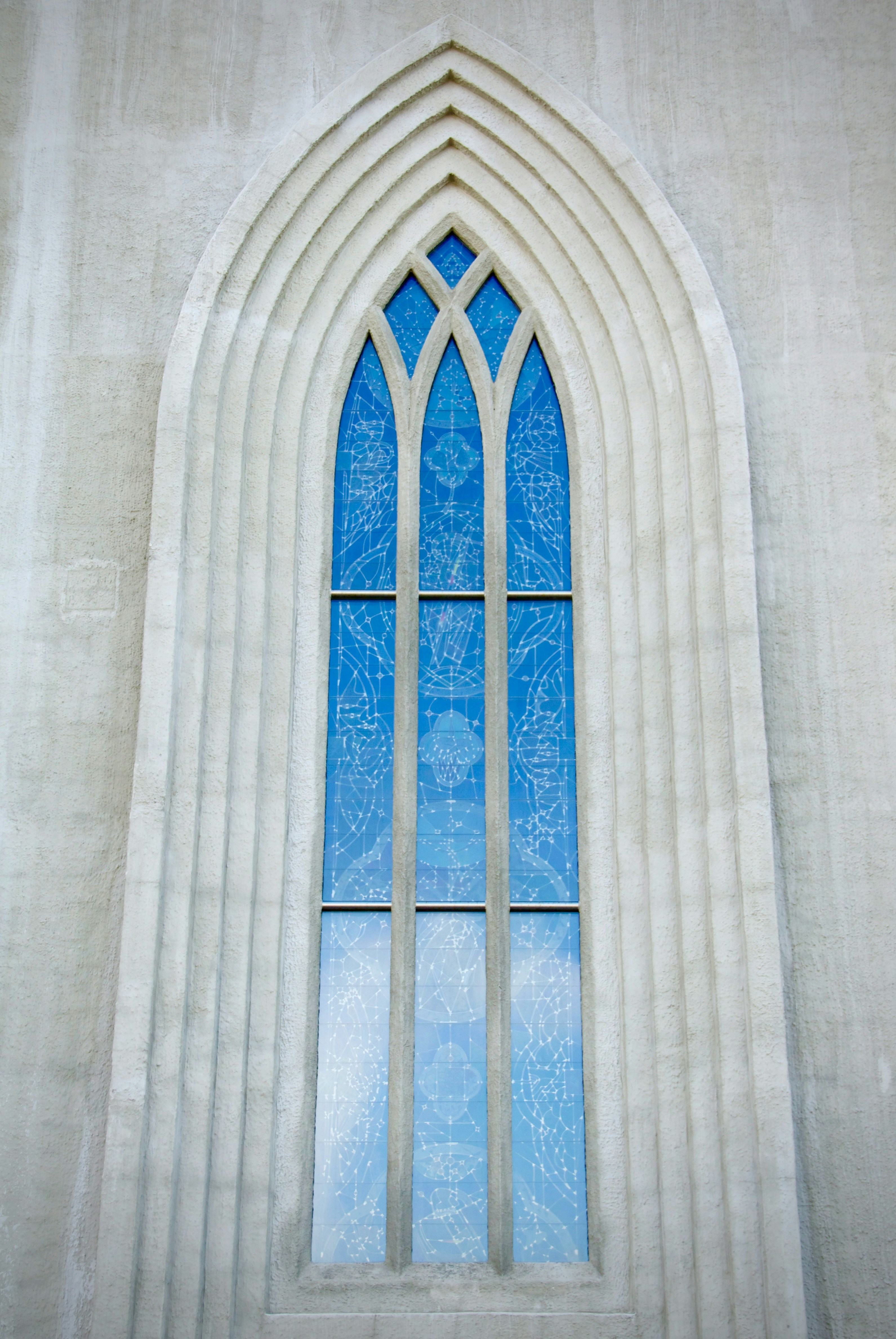 Blue Tracery Through Quiet Stone: A Gothic Window Portrait