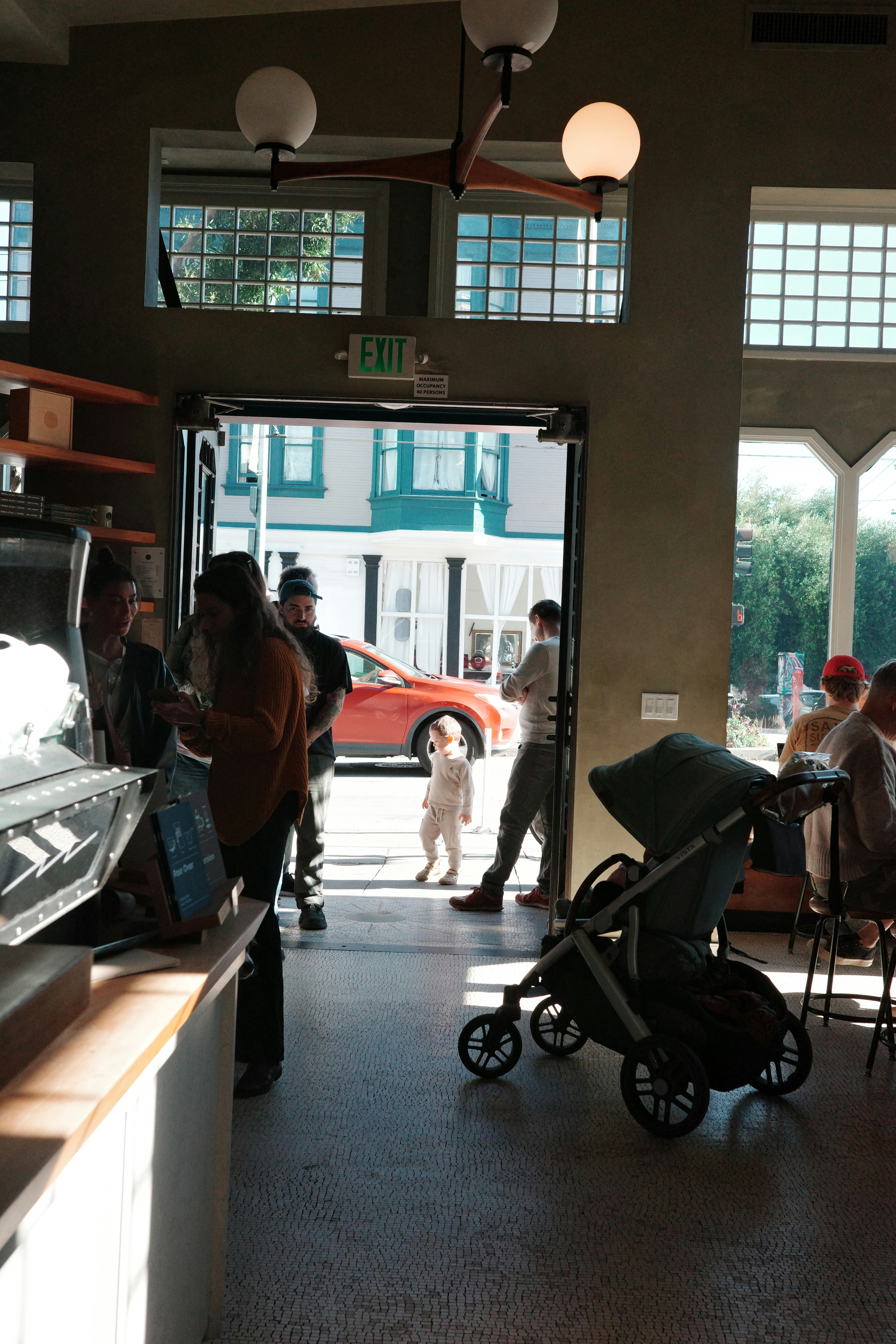 Tiny Explorer at the Sunlit Cafe Doorway