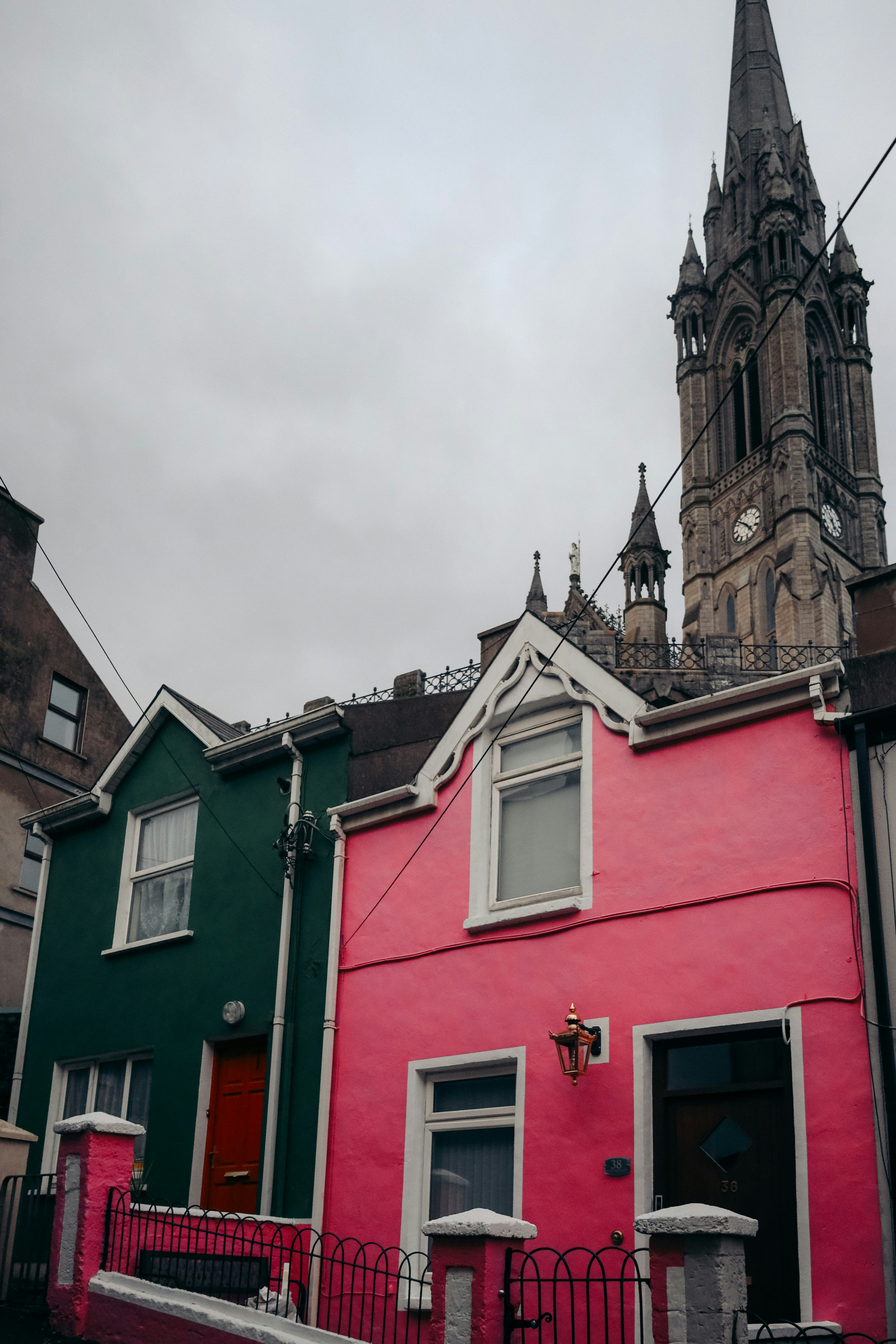 Candy-Pink Cottage Anchored by a Gothic Spire
