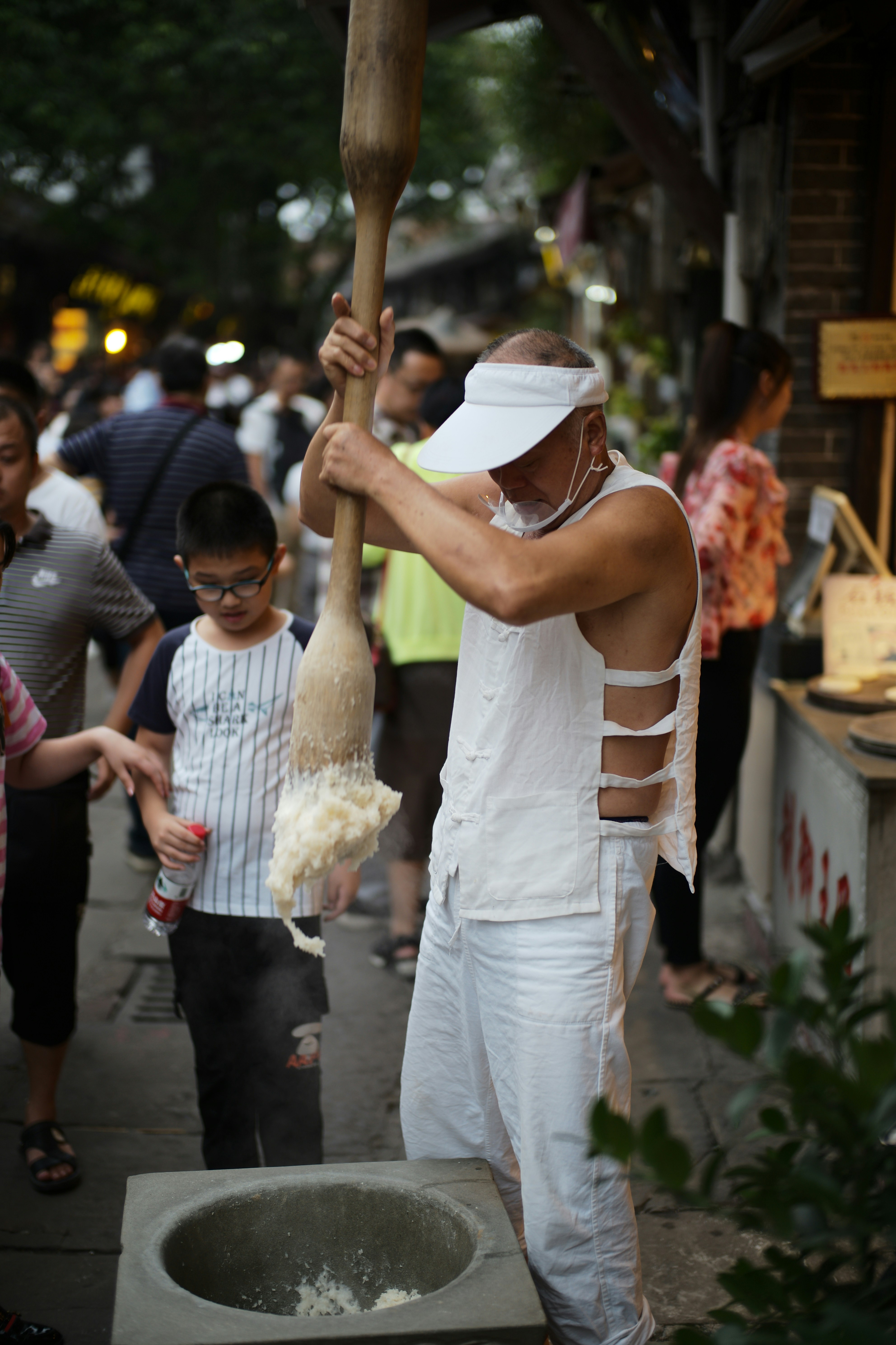 White Garb and Wooden Pulse: Pounding Mochi in a Bustling Street Market