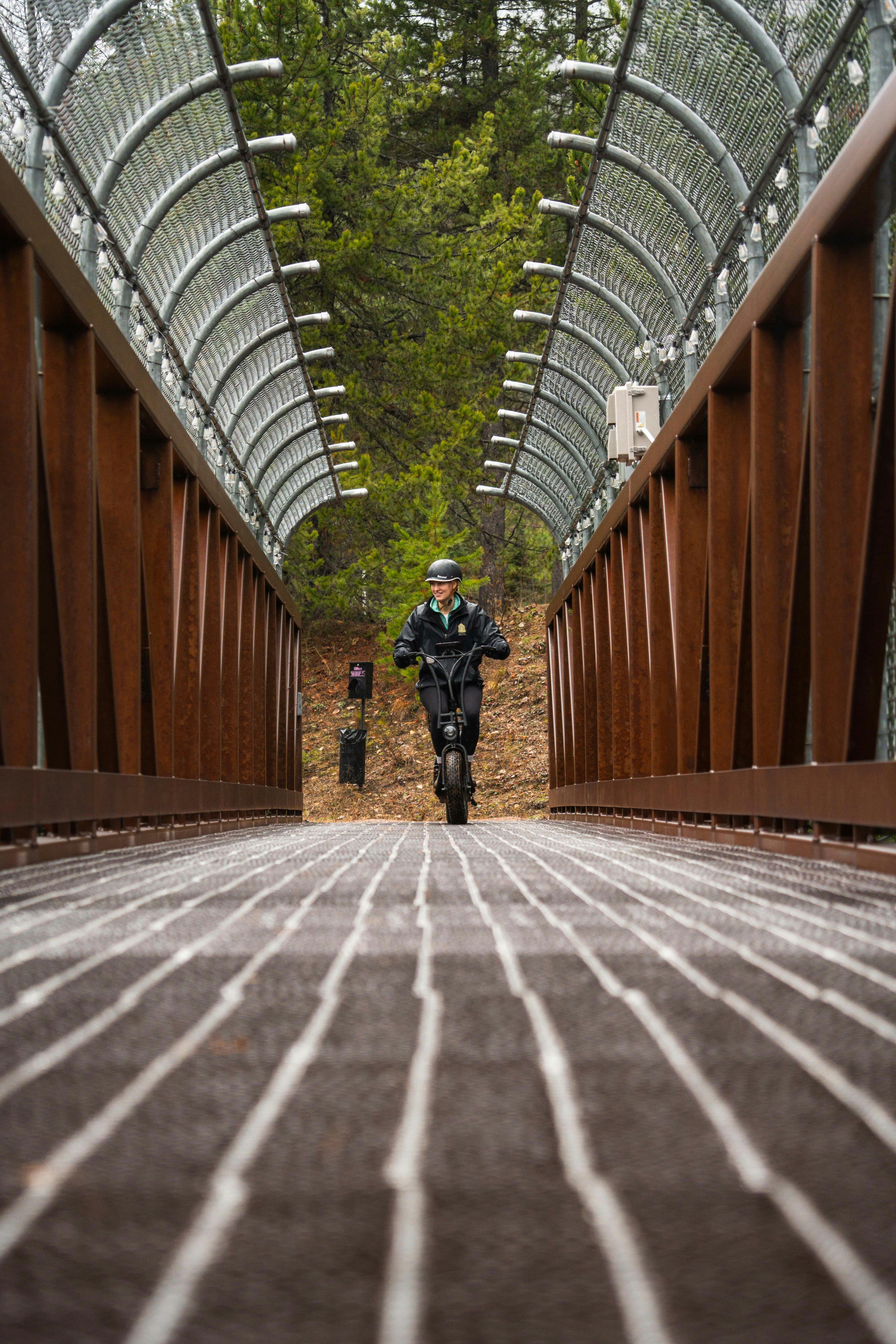 Lone Rider on a Curved Bridge