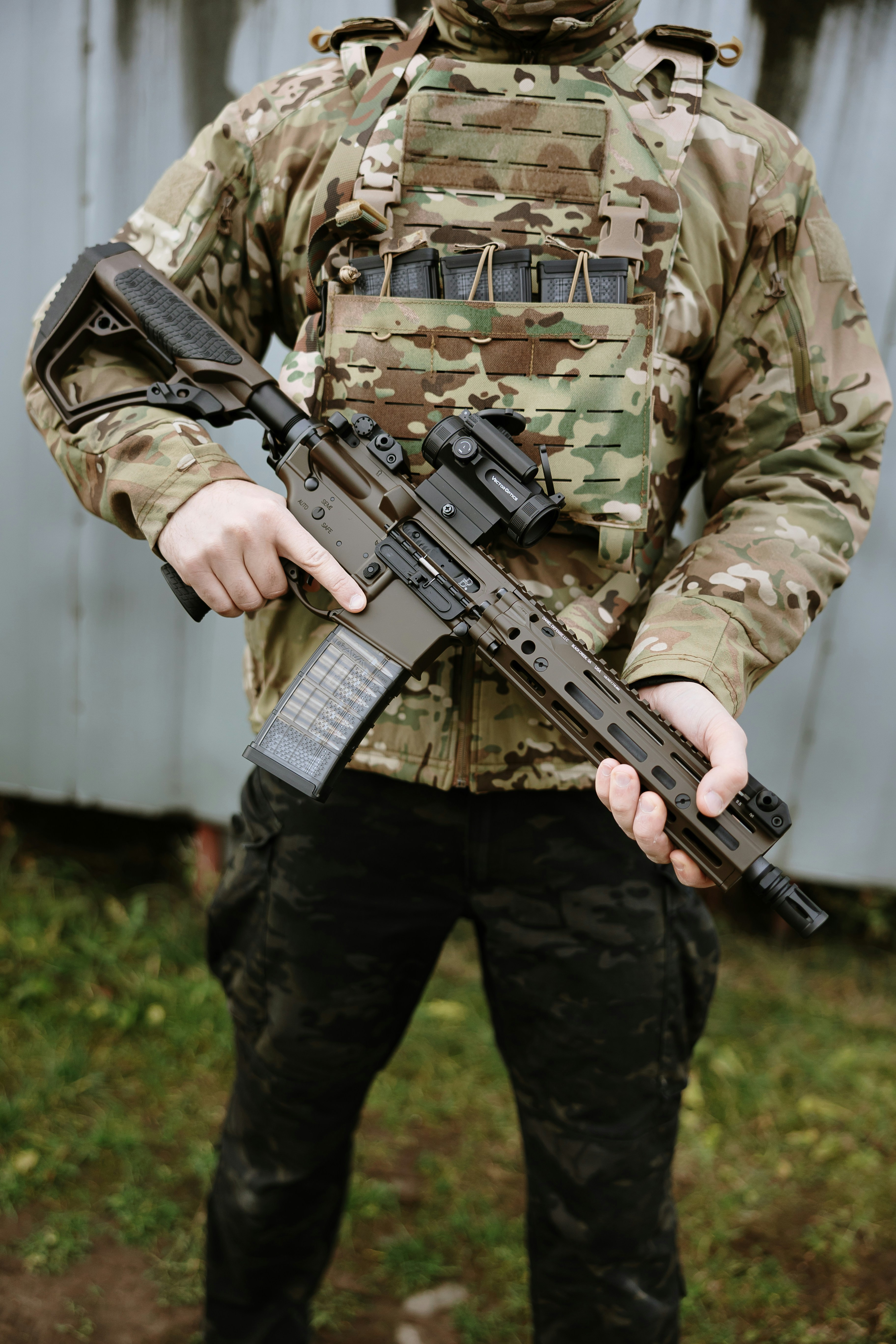 Camouflaged Resolve: A Soldier in Multicam Holds a Modern Modular Rifle