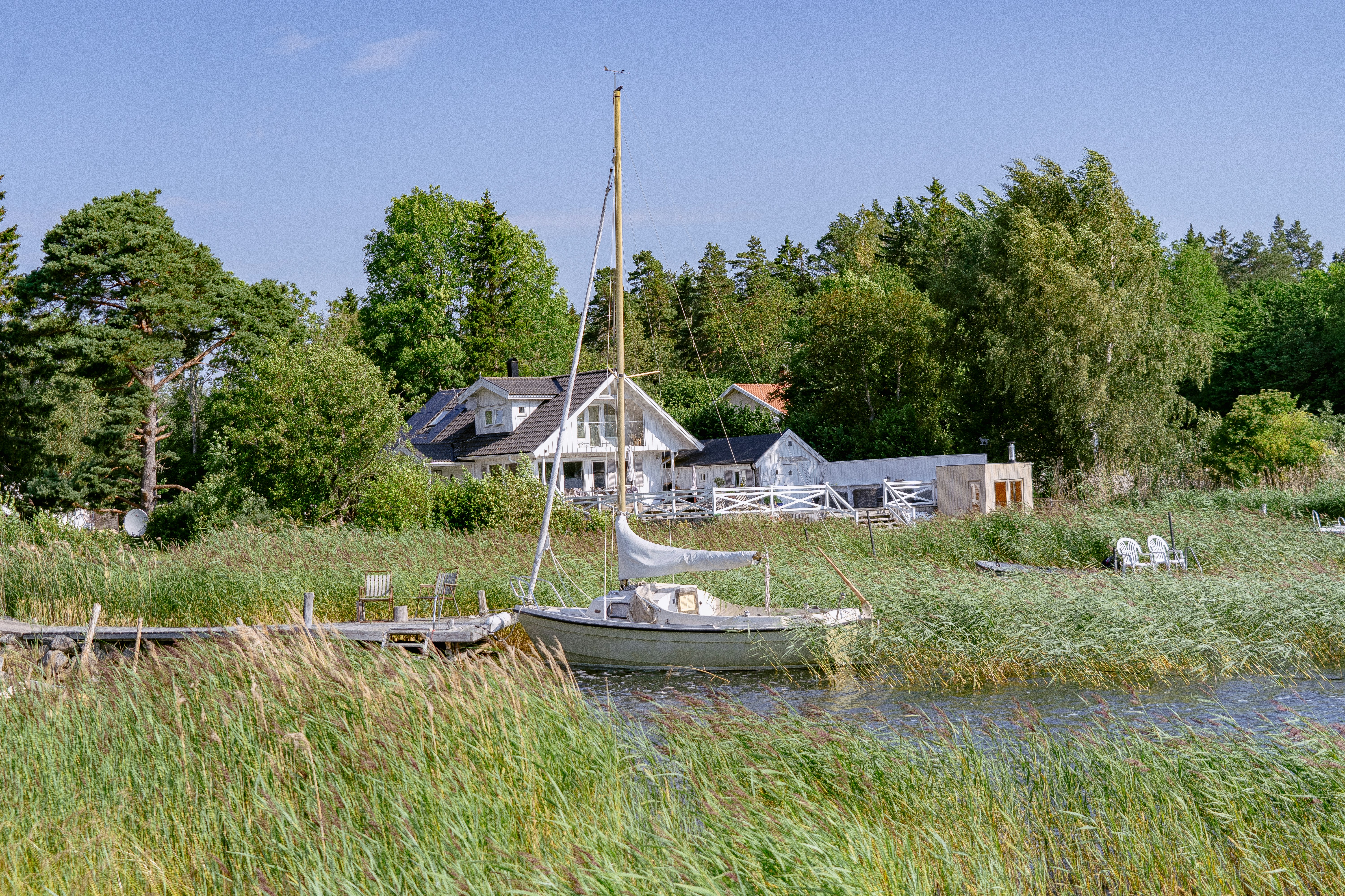Sailboat at the Edge of a Quiet Lakeside Village