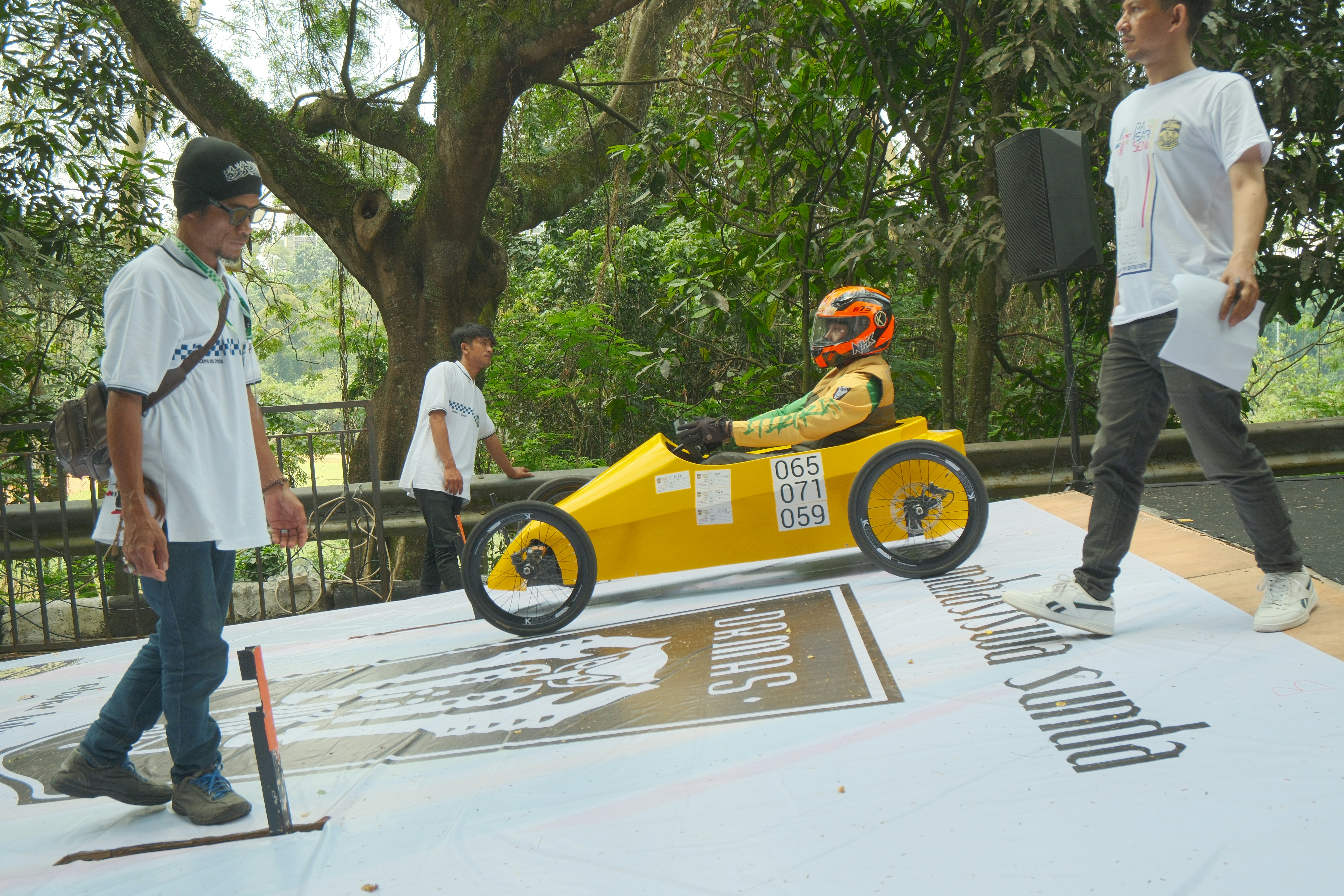 Man in racing suit sits in yellow go-kart photo – Free Team Image on ...