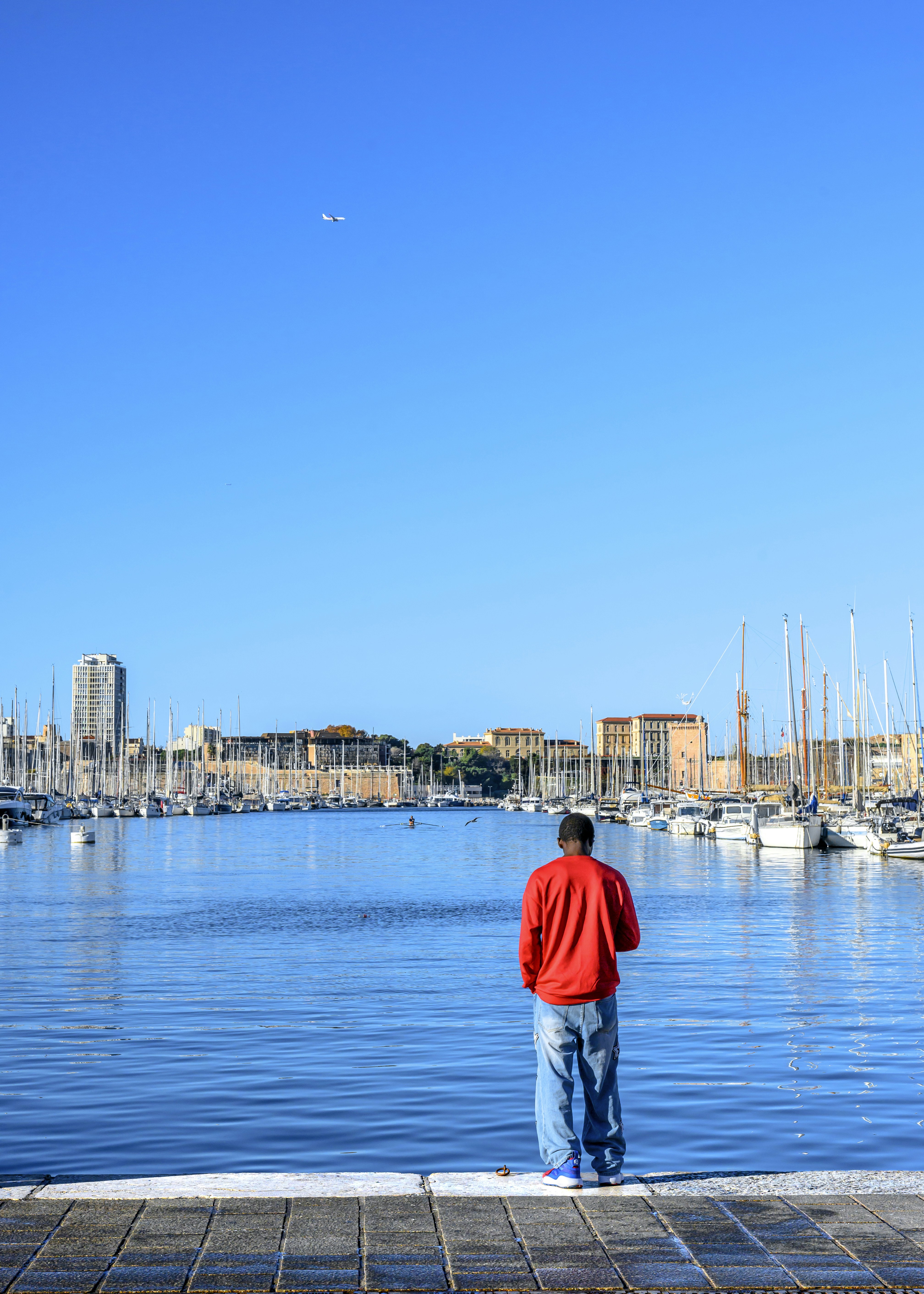 Red at the Marina: A Solitary Moment by the Docks