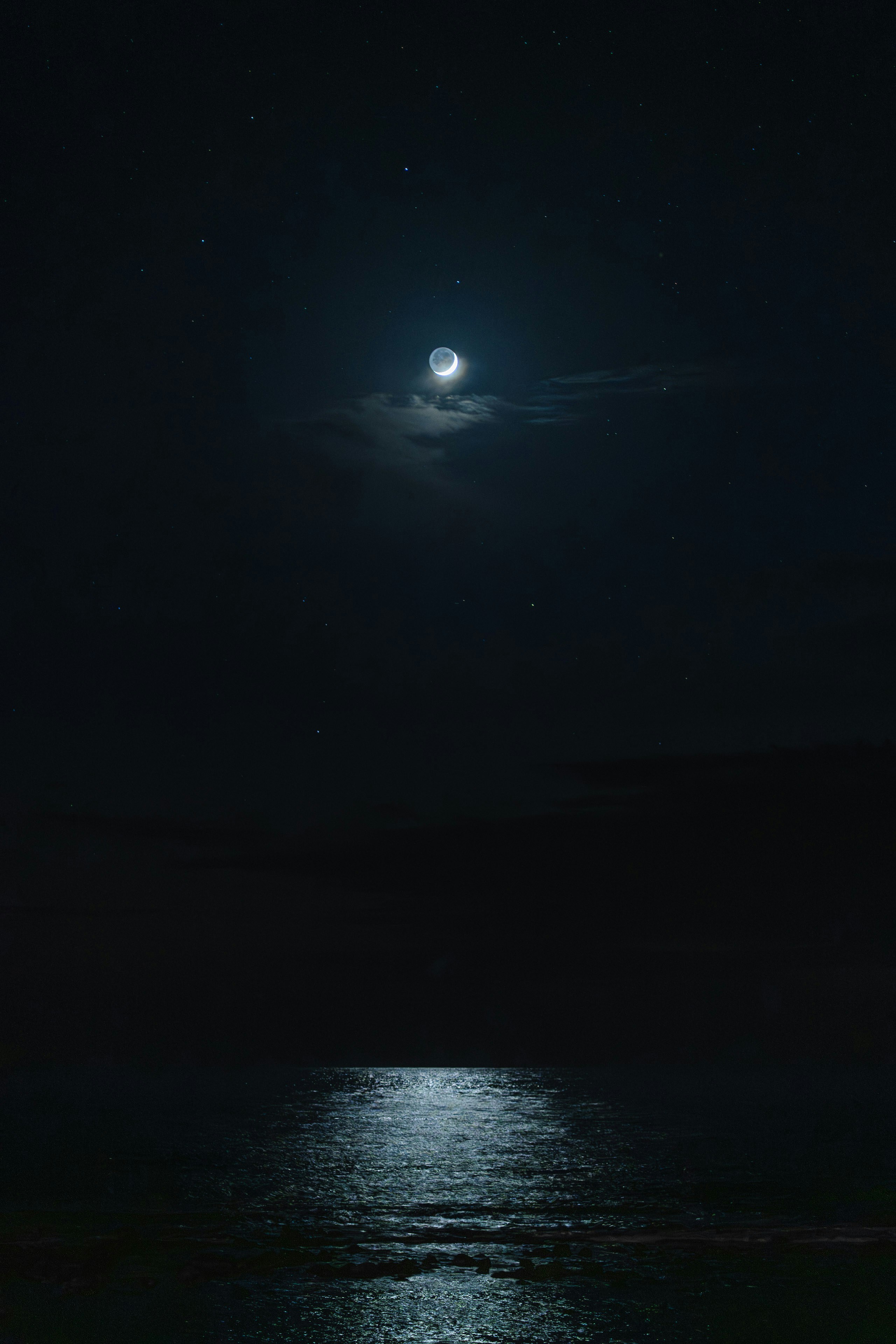 Moon's Crescent Casts a Silver Path Across the Quiet Sea