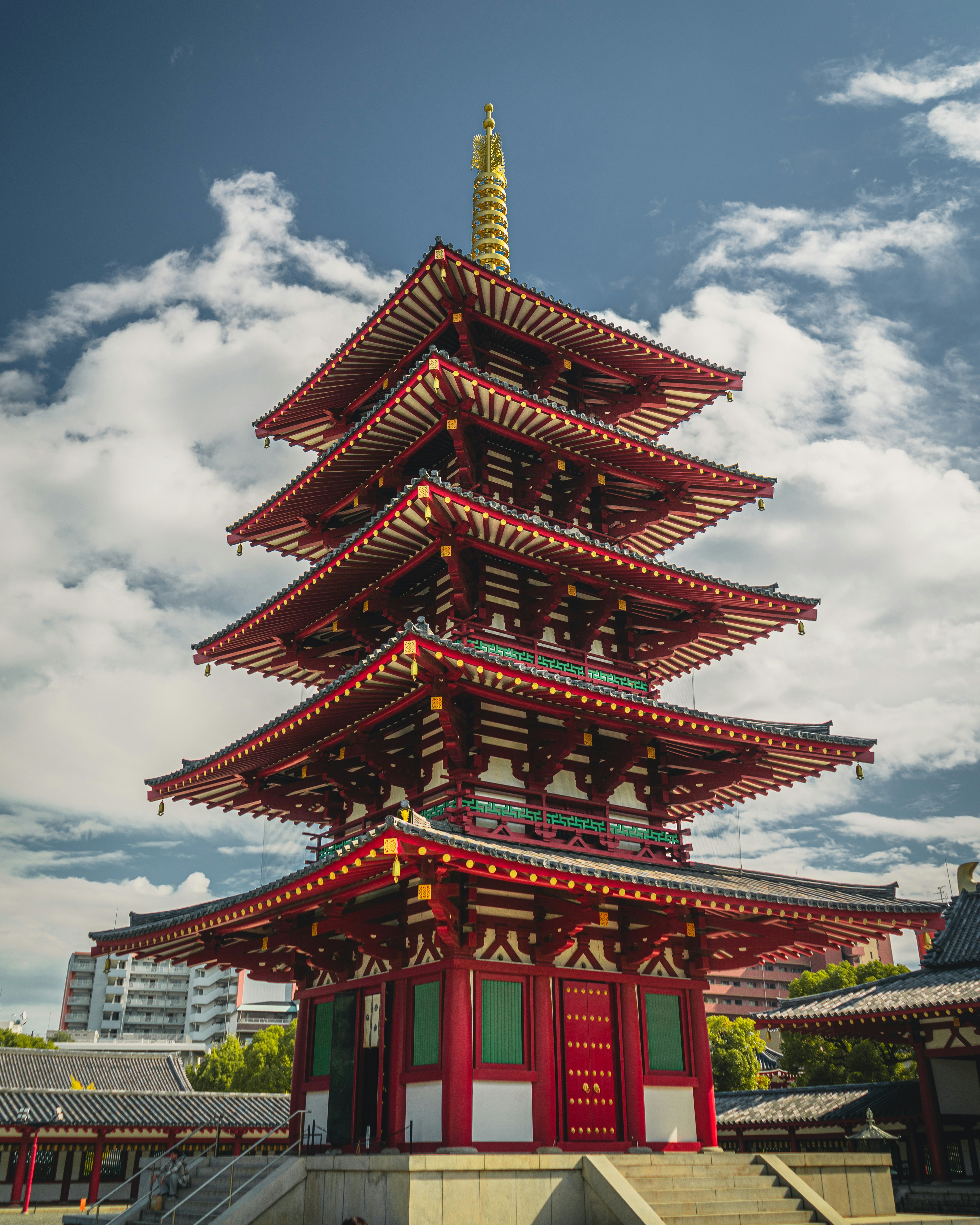 Crimson Spire on a Cerulean Day: A Five-Tier Pagoda in the Temple Courtyard