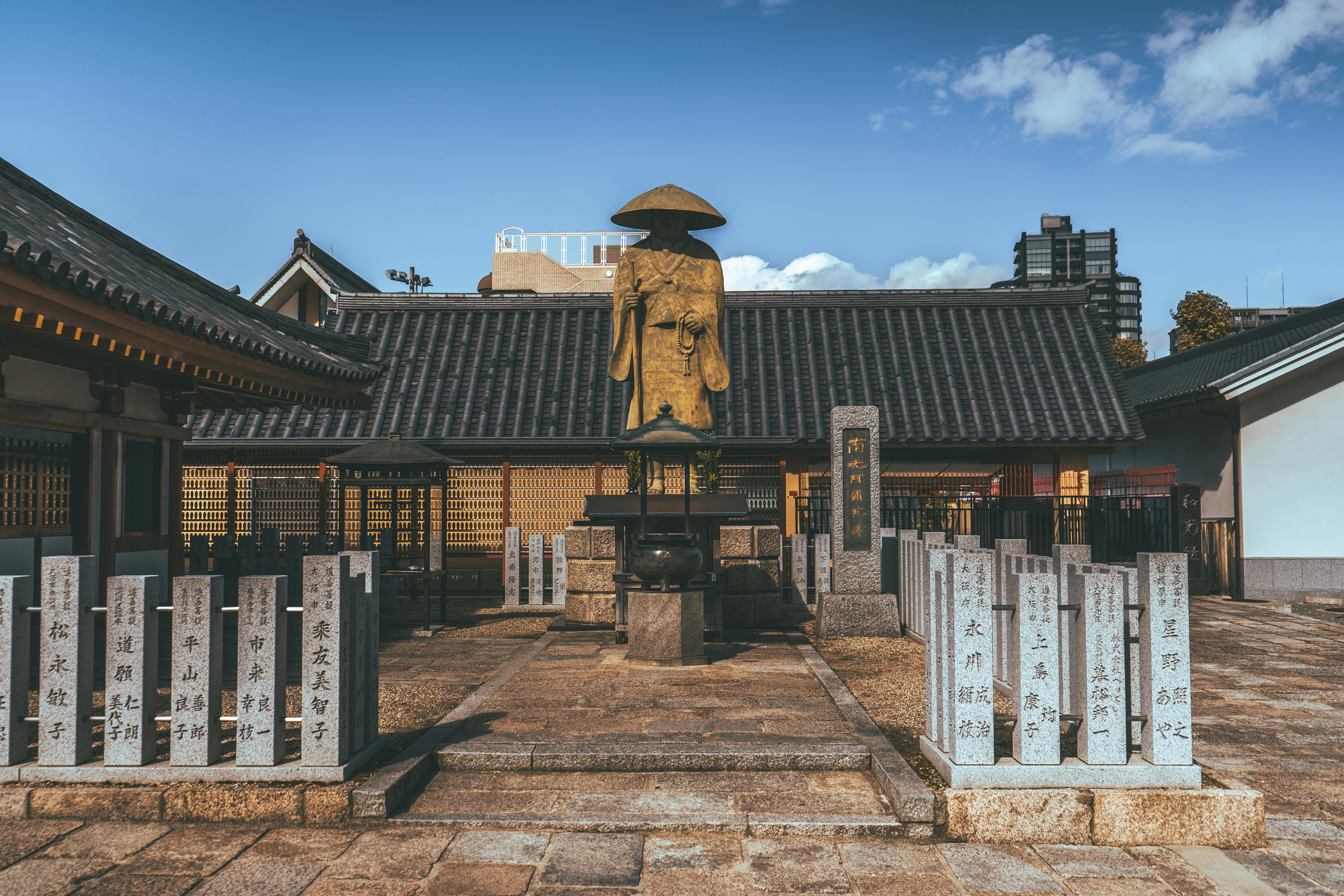 The Quiet Sentinel: Bronze Statue in a Temple Courtyard