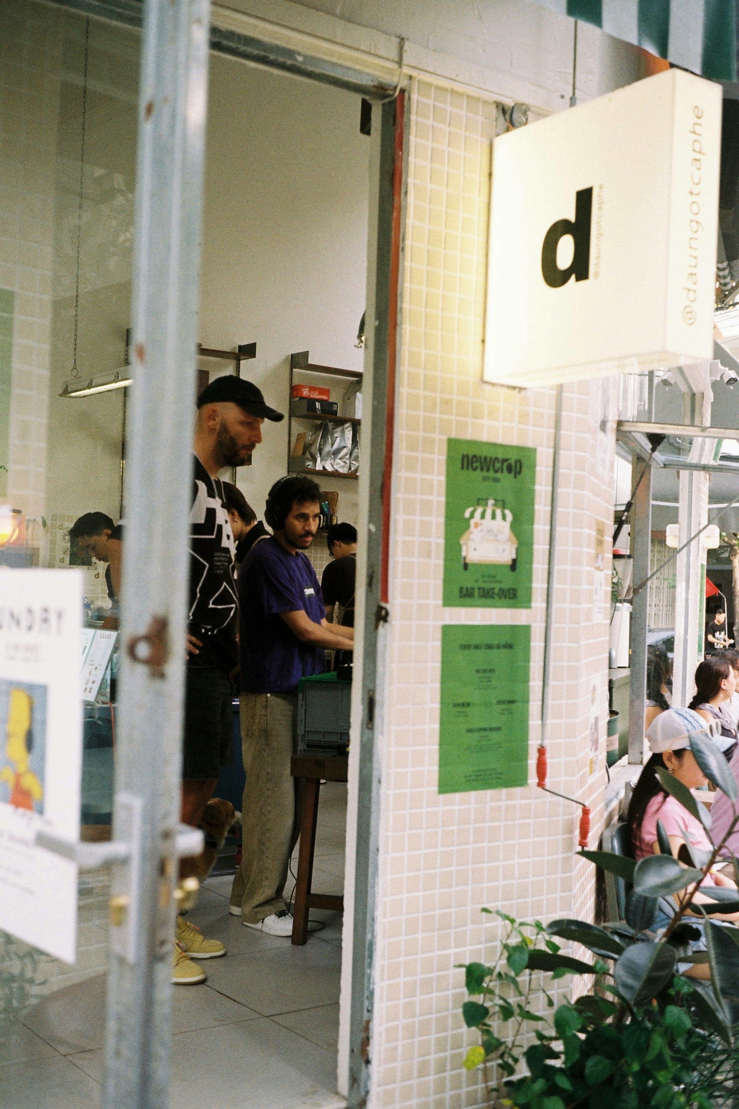 Threshold at the Counter: A Quiet Moment in a Small Café-Style Shop