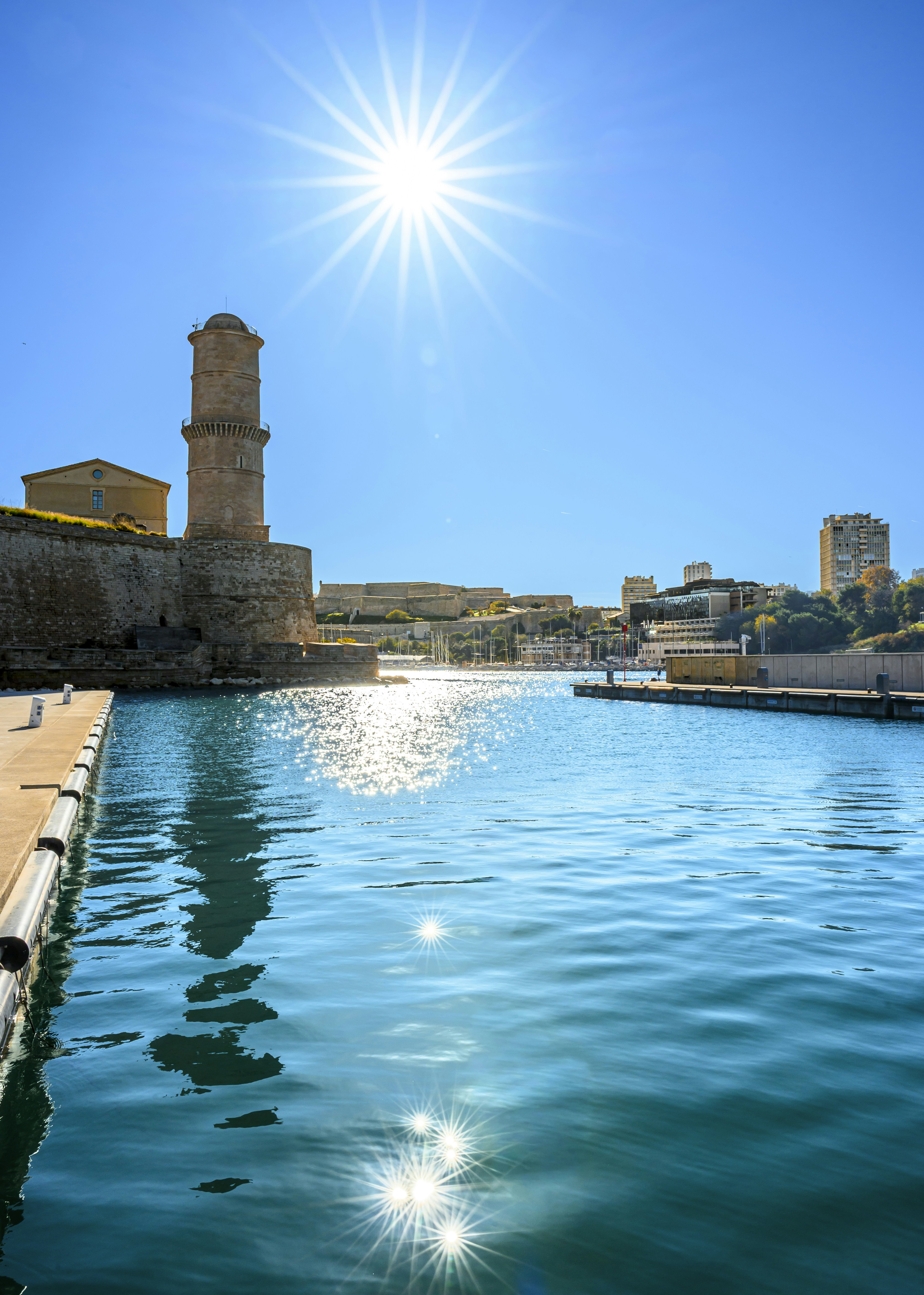 Tidefront Sentinel: The Stone Tower Beside a Sunlit Harbor