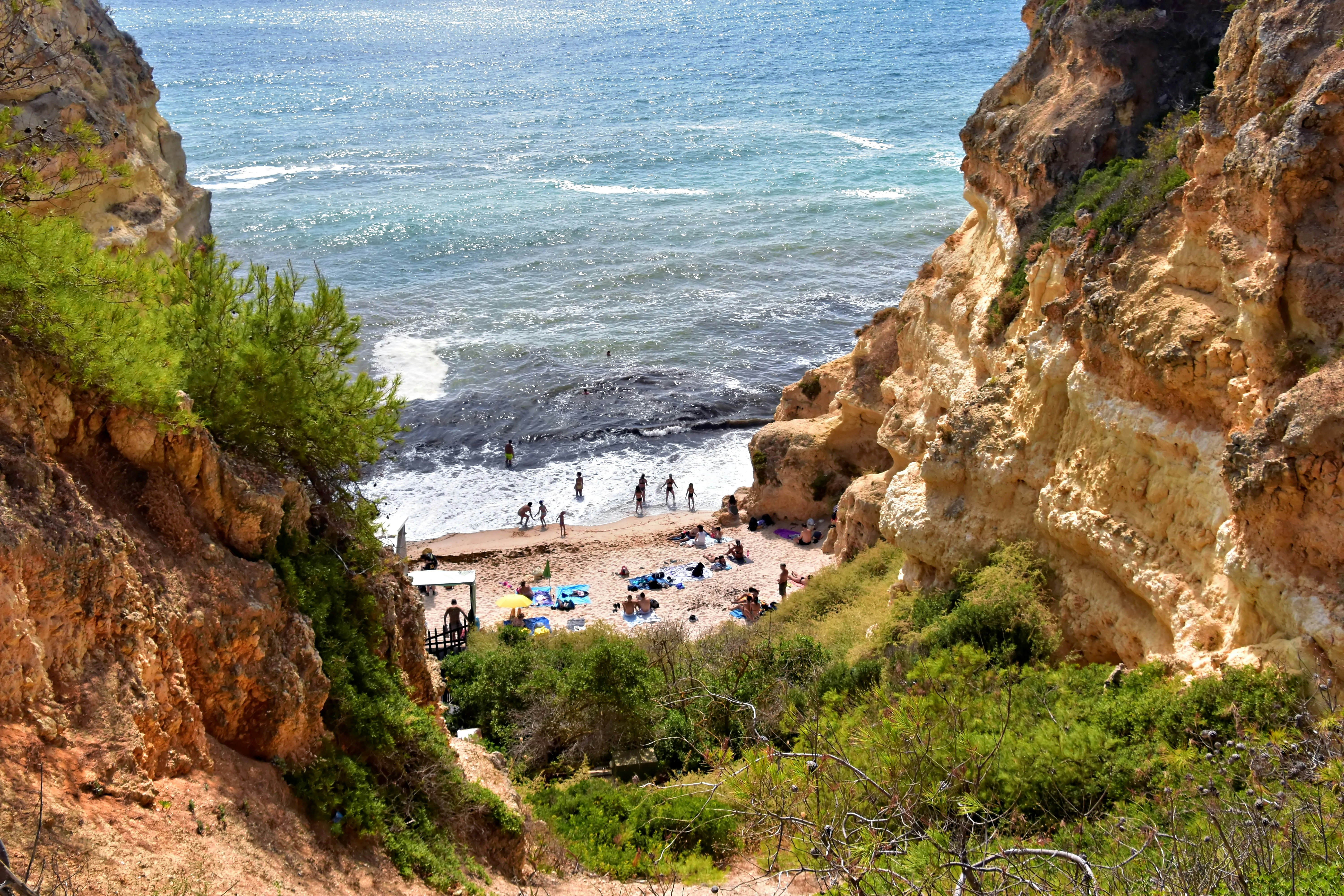 Cove Between Stone Sentinels: A Sunlit Beach Framed by Cliffs