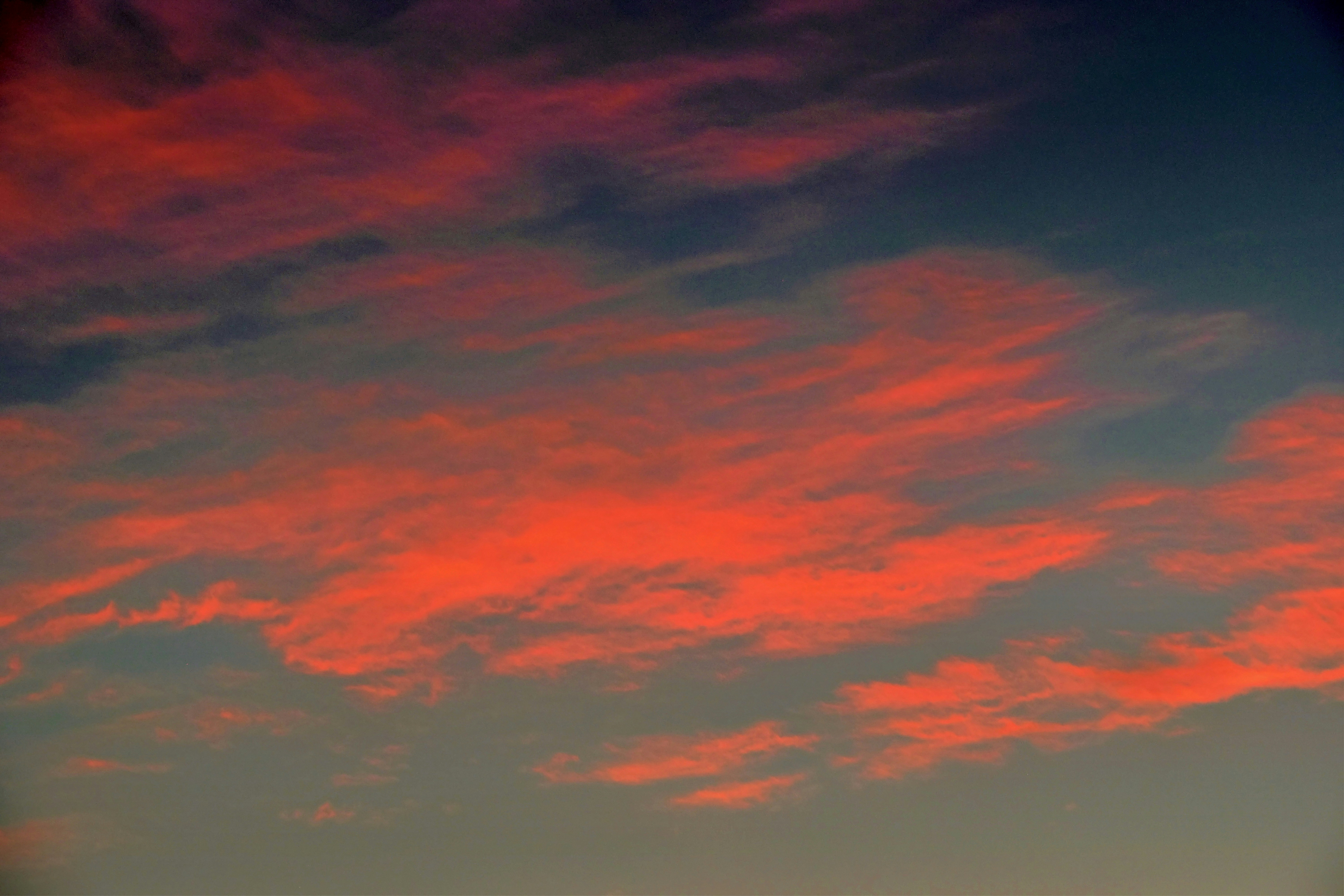 Red clouds in a dark sky at dusk photo – Free Sunset Image on Unsplash