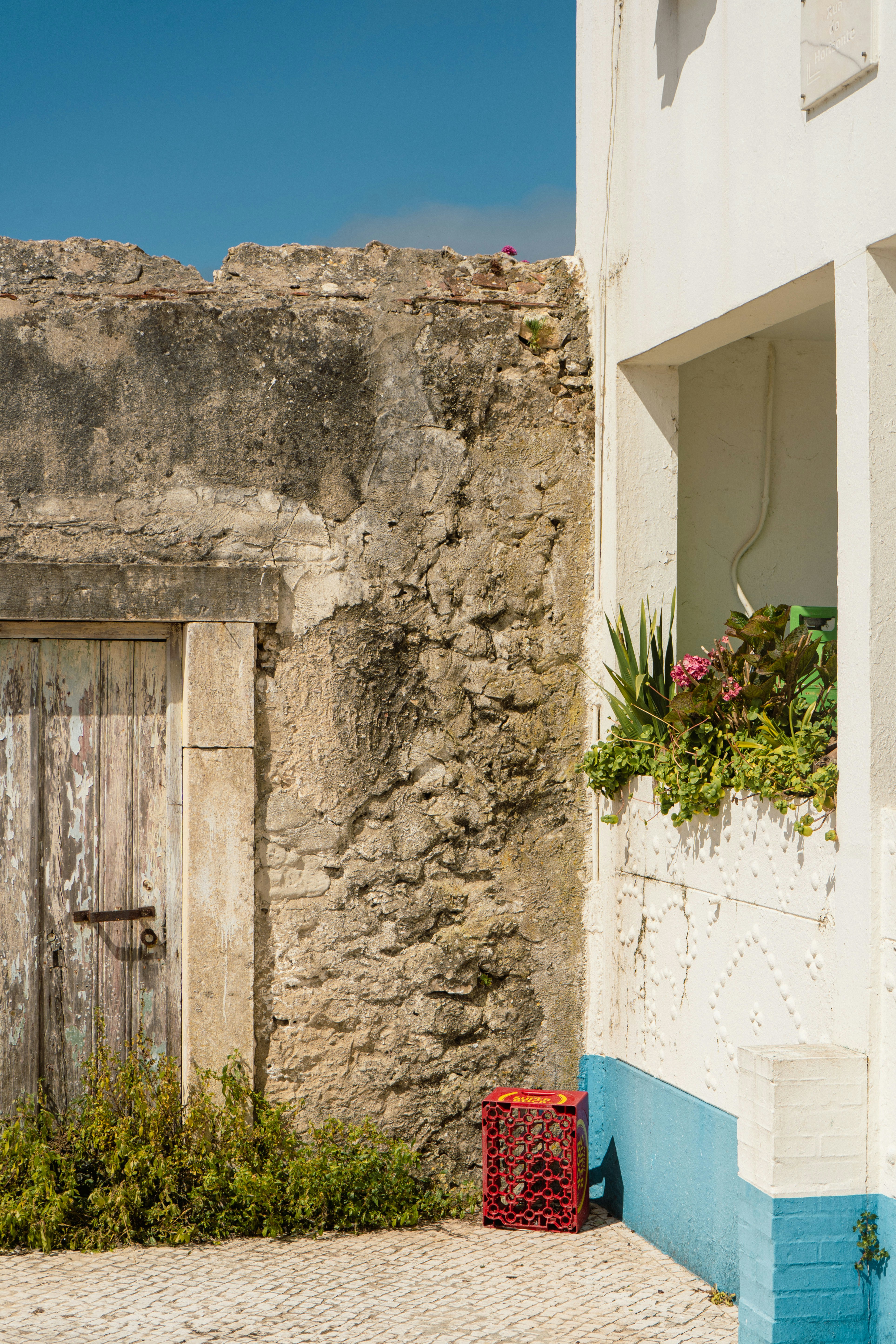 Crimson Crate at the Edge of a Mediterranean Stone Courtyard