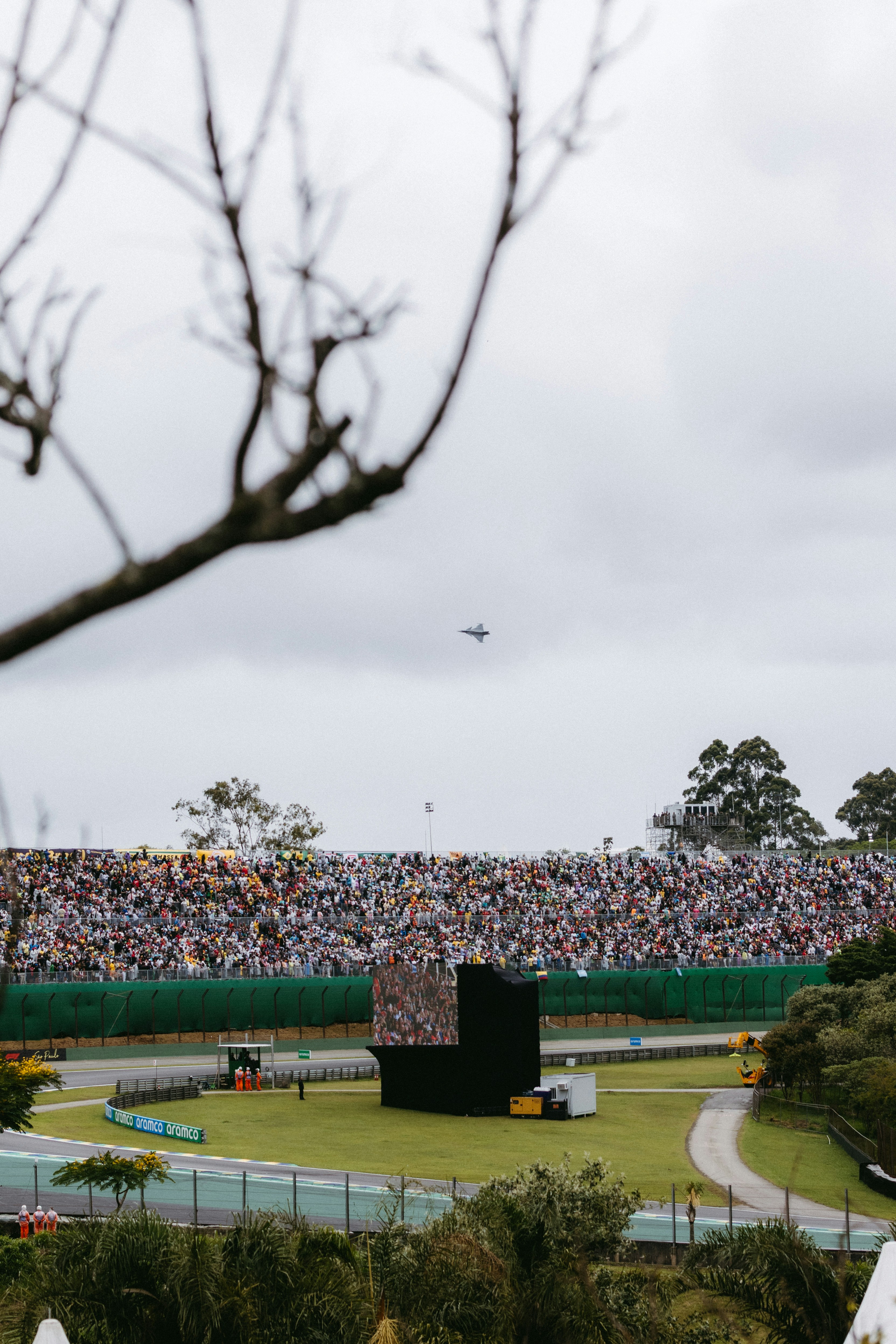 Airplane flies over crowded stadium during a sporting event photo ...