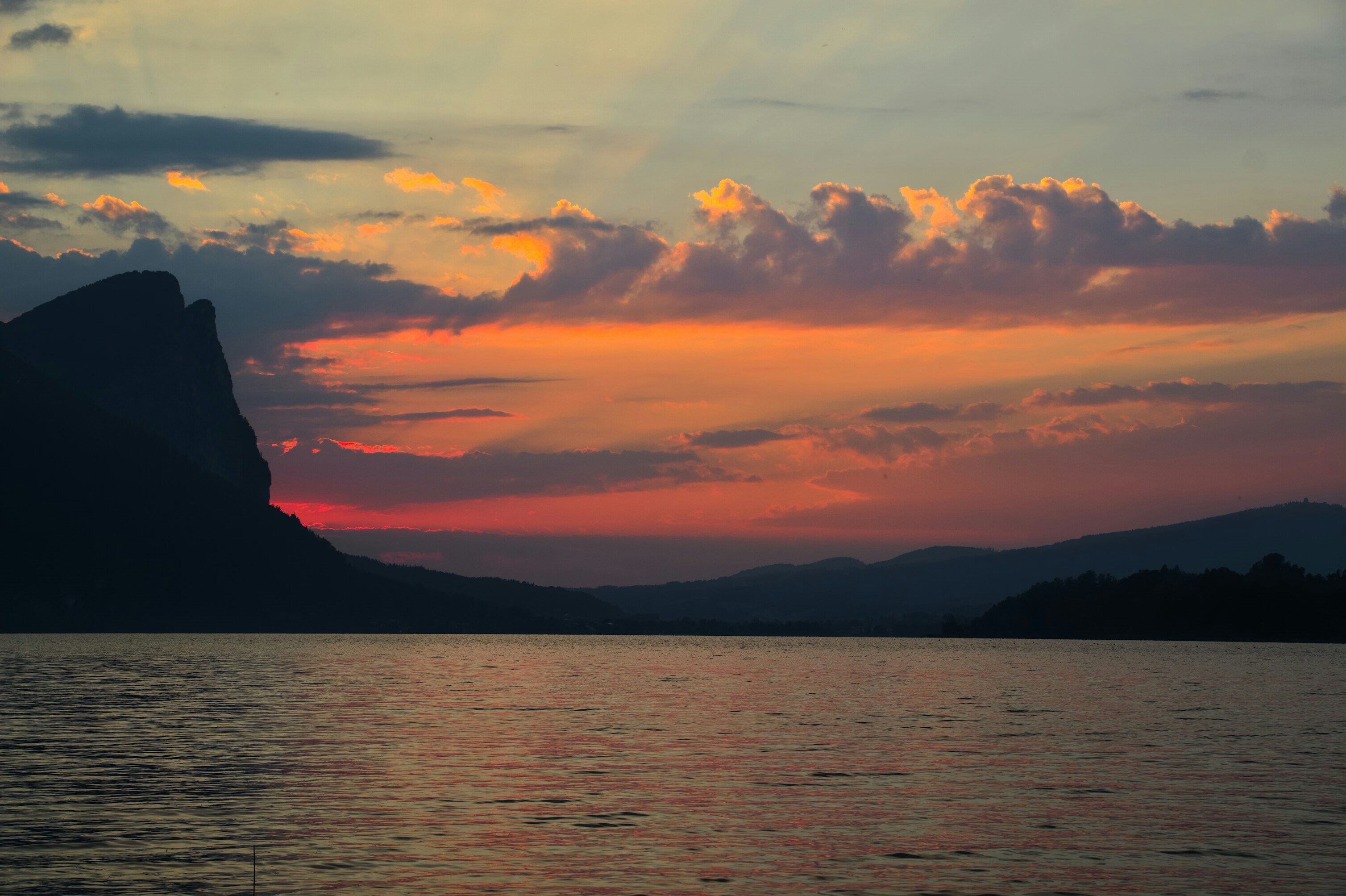 Ember Horizon: Silhouettes at Dusk Over a Quiet Sea